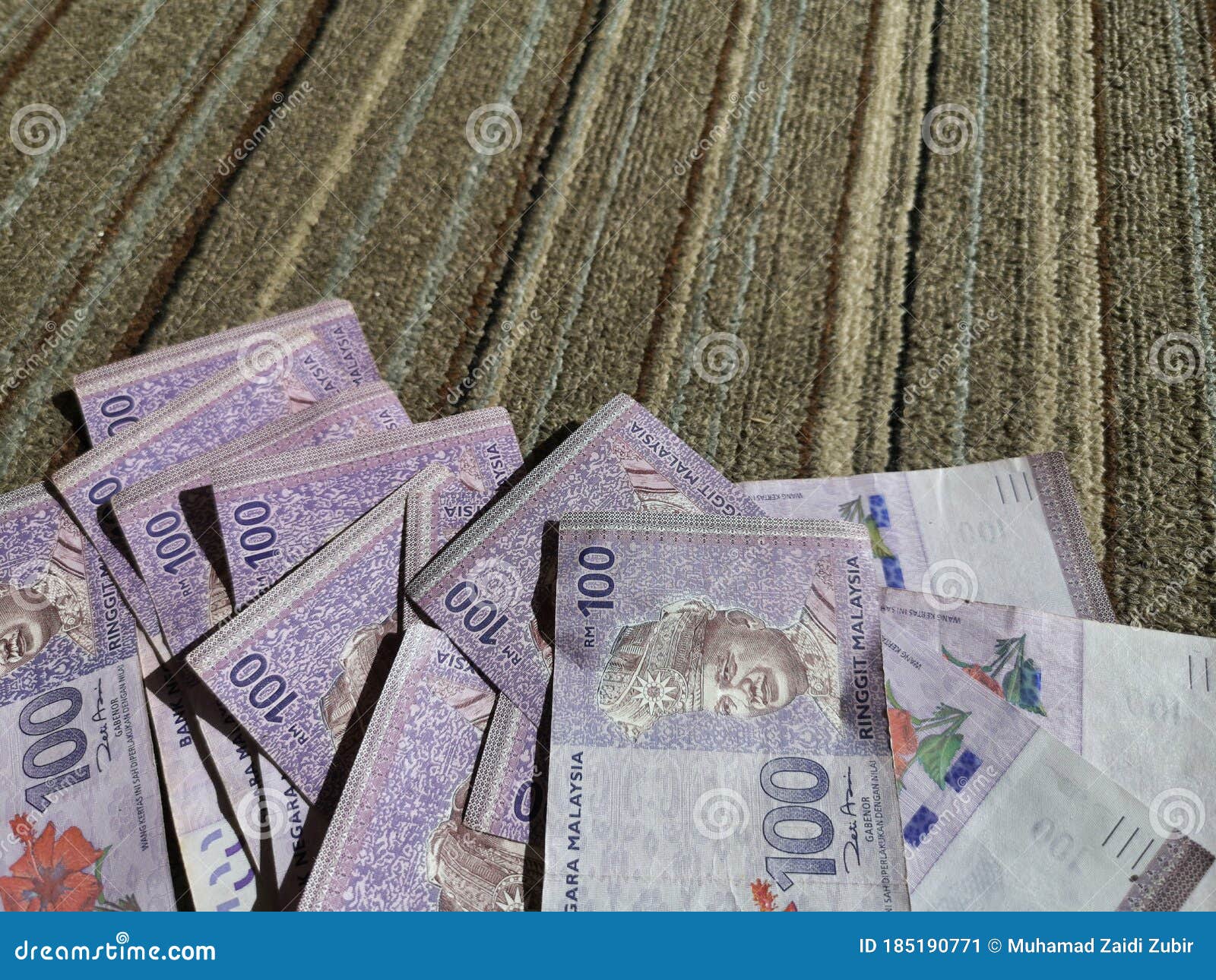 There is a Hundred Ringgit Malaysia Scattered on the Carpet. Stock ...