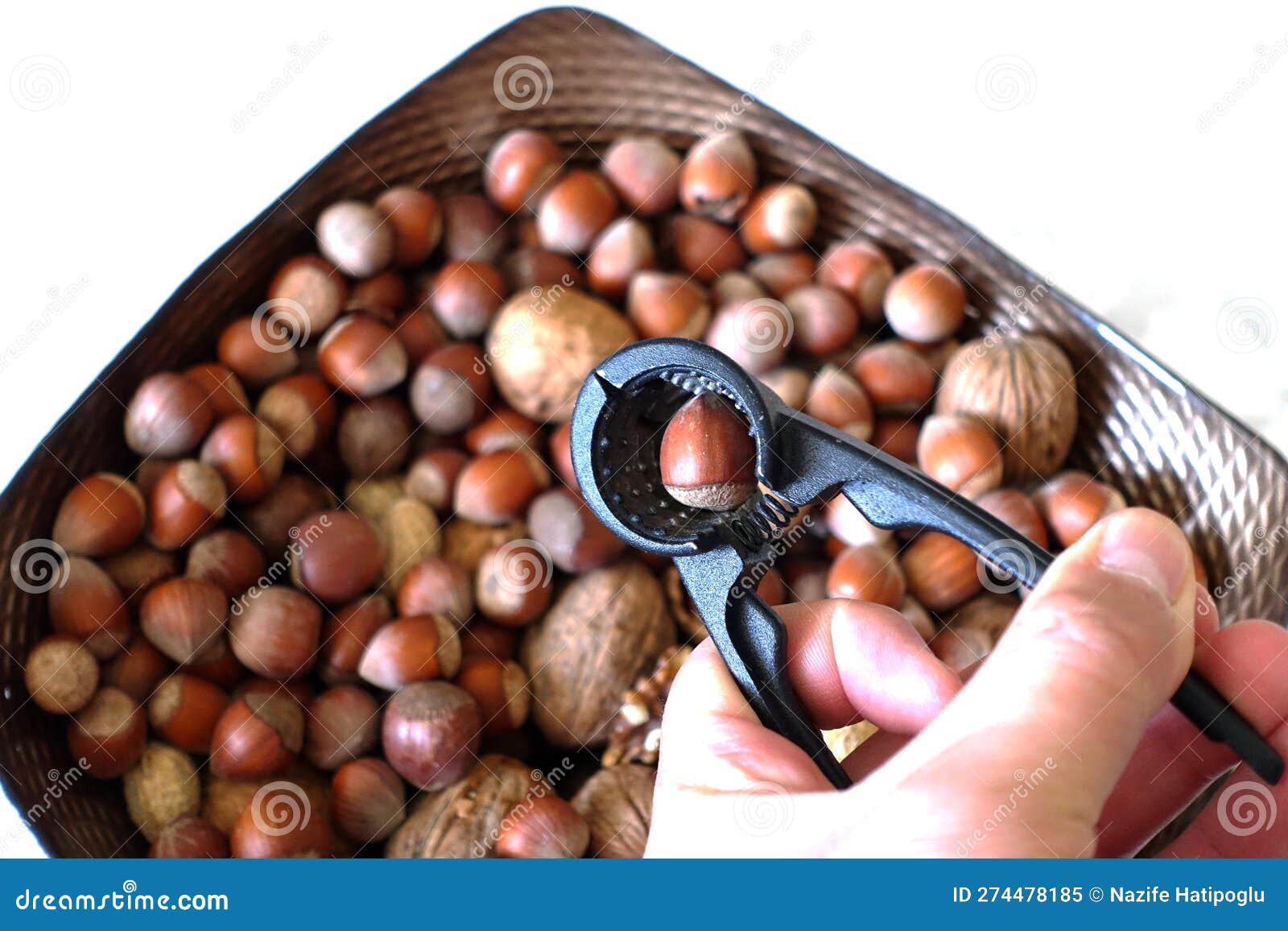 There are a Lot of Walnuts and Hazelnuts in a Bowl, Walnut Cracker and ...