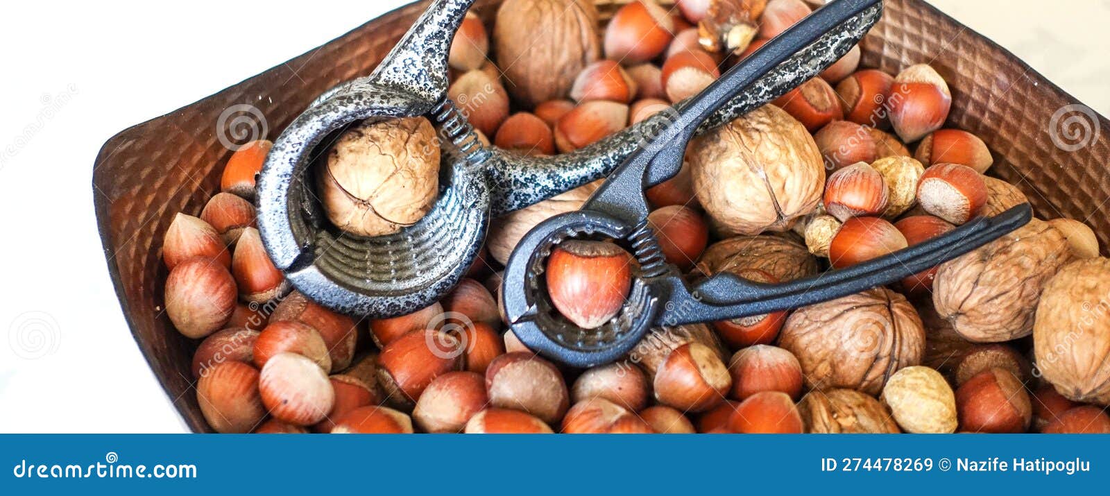 There are a Lot of Walnuts and Hazelnuts in a Bowl, Walnut Cracker and ...