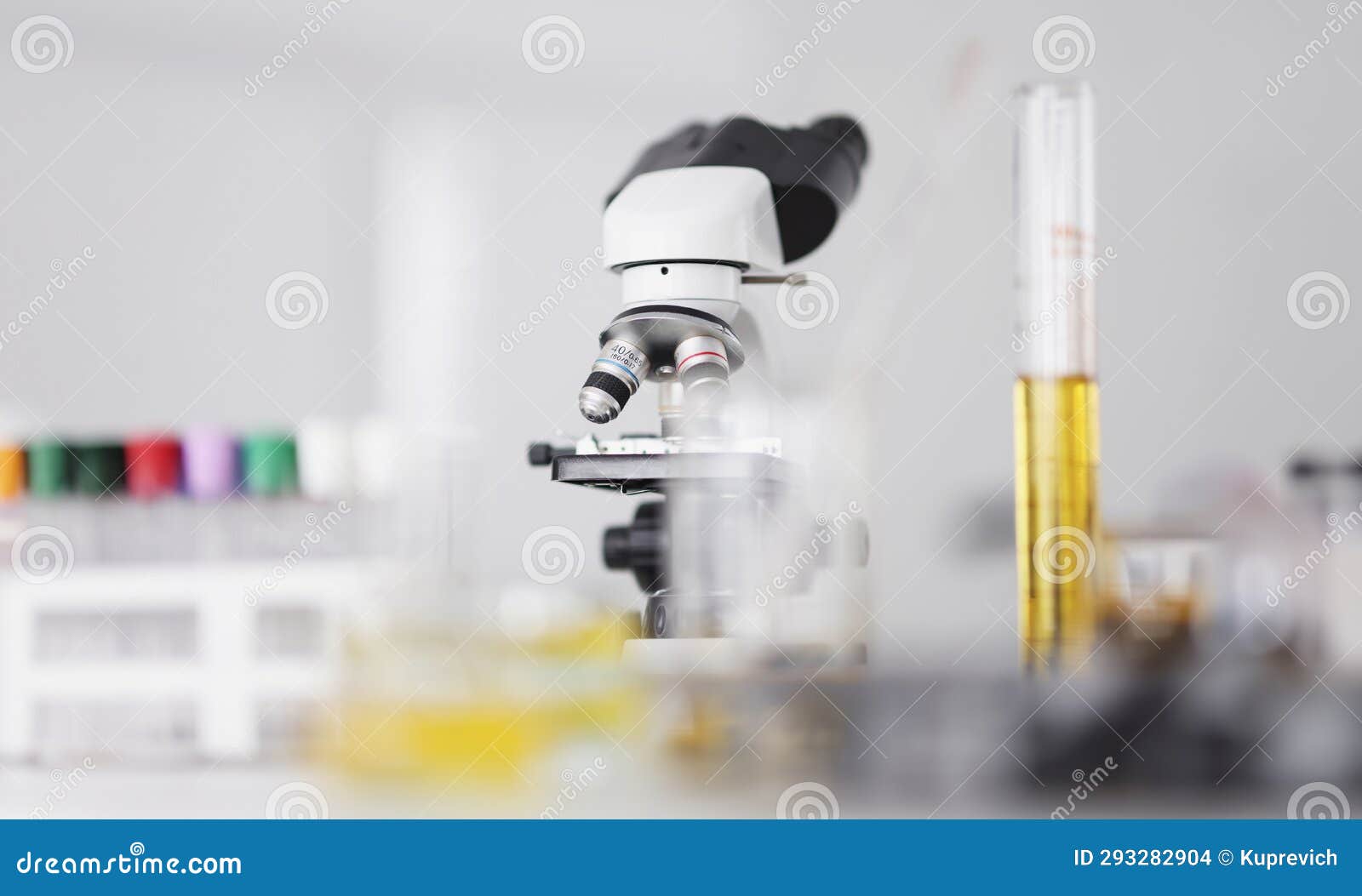 There is Microscope and Test Tube with Yellow Liquid in Laboratory ...