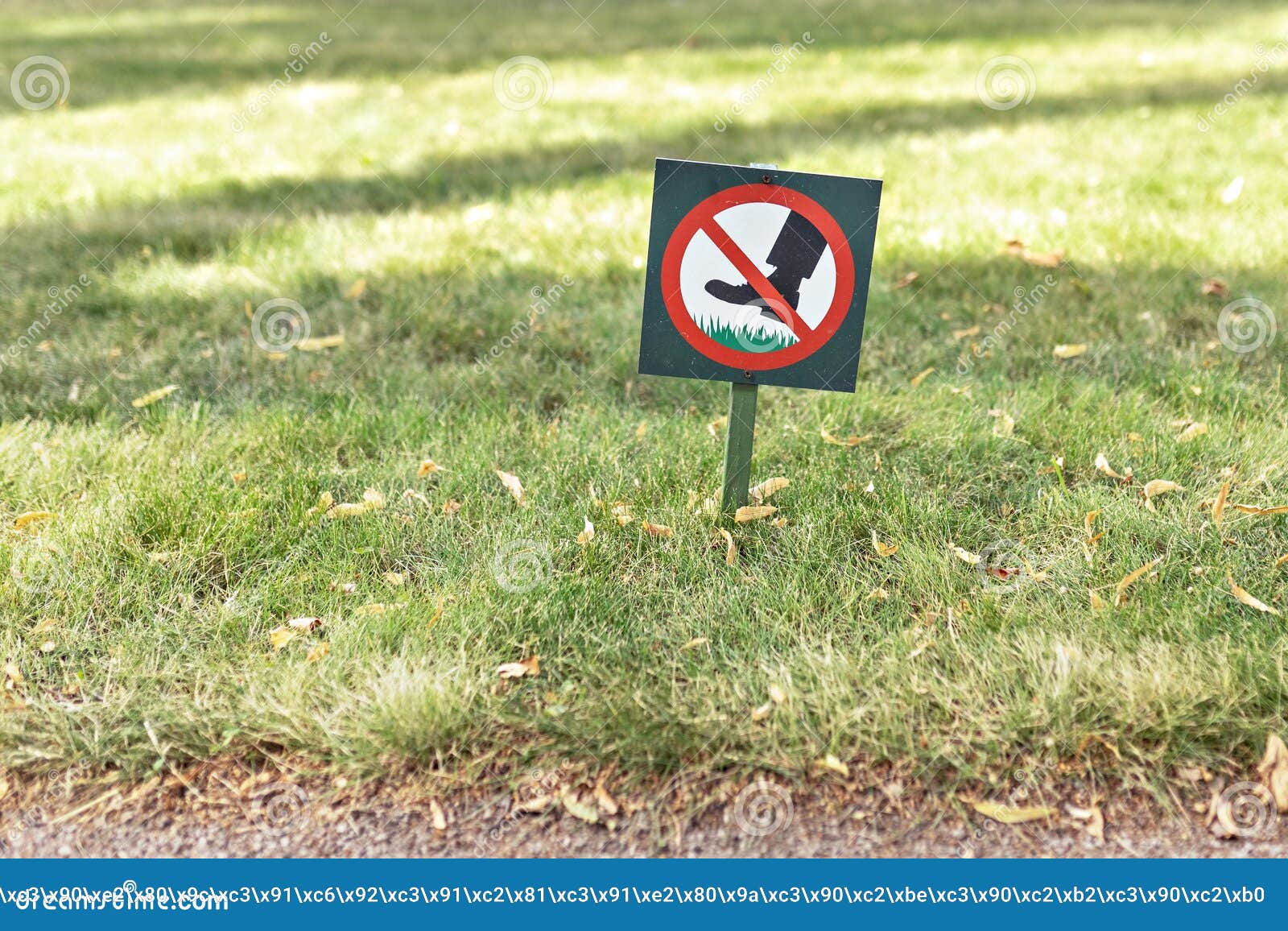 There is a Sign on the Lawn with a Sign Forbidding Walking on the Grass ...
