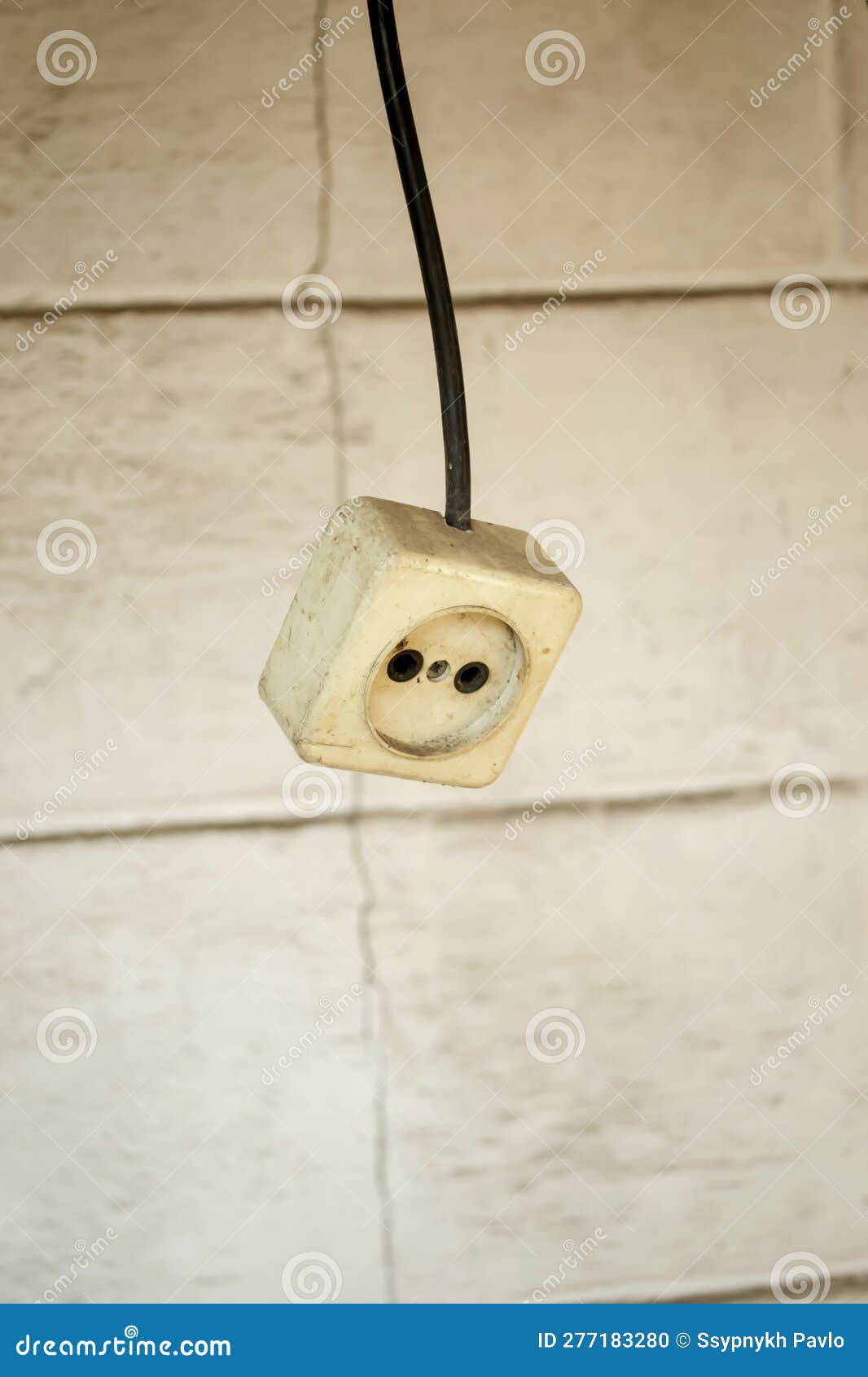 There is a Socket Hanging. the Socket Hangs on a Black Wire. the ...