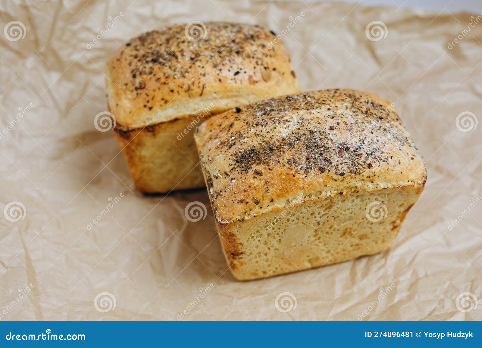 There are Two Rectangular Breads on the Paper Which is on the Table ...