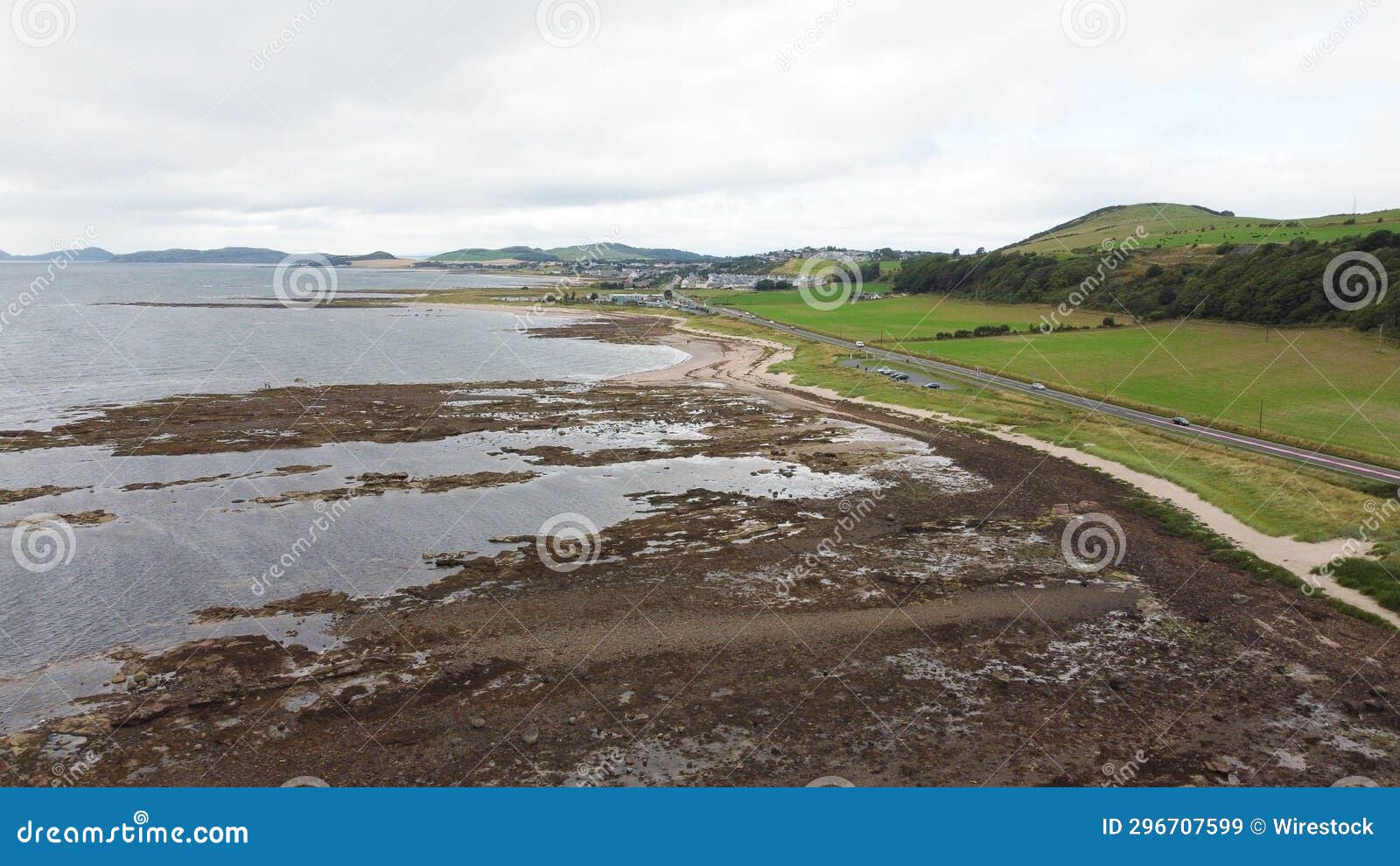 There is a Very Large Grassy Area with a Small River in Front of it ...
