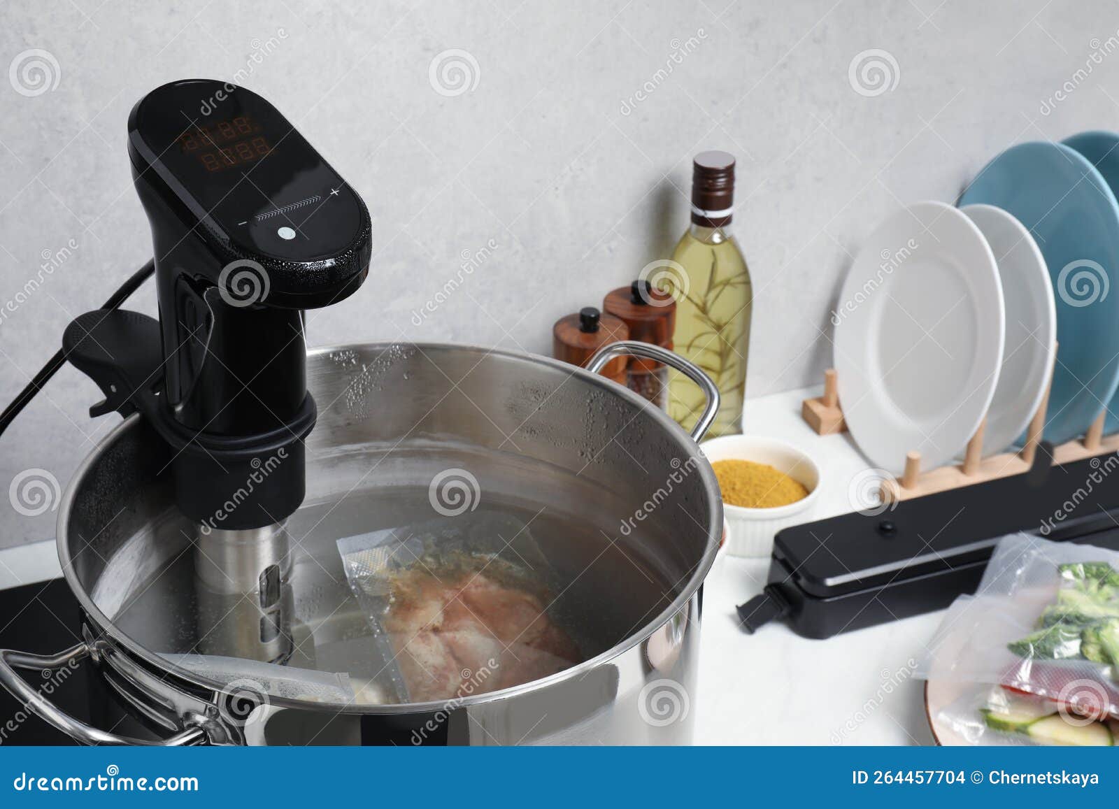 Thermal Immersion Circulator and Vacuum Packed Meat in Pot on Table ...