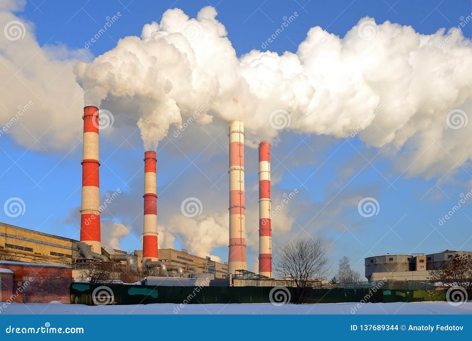 Thermal Power Plant Smoke From The Chimney Against Blue Sky Stock