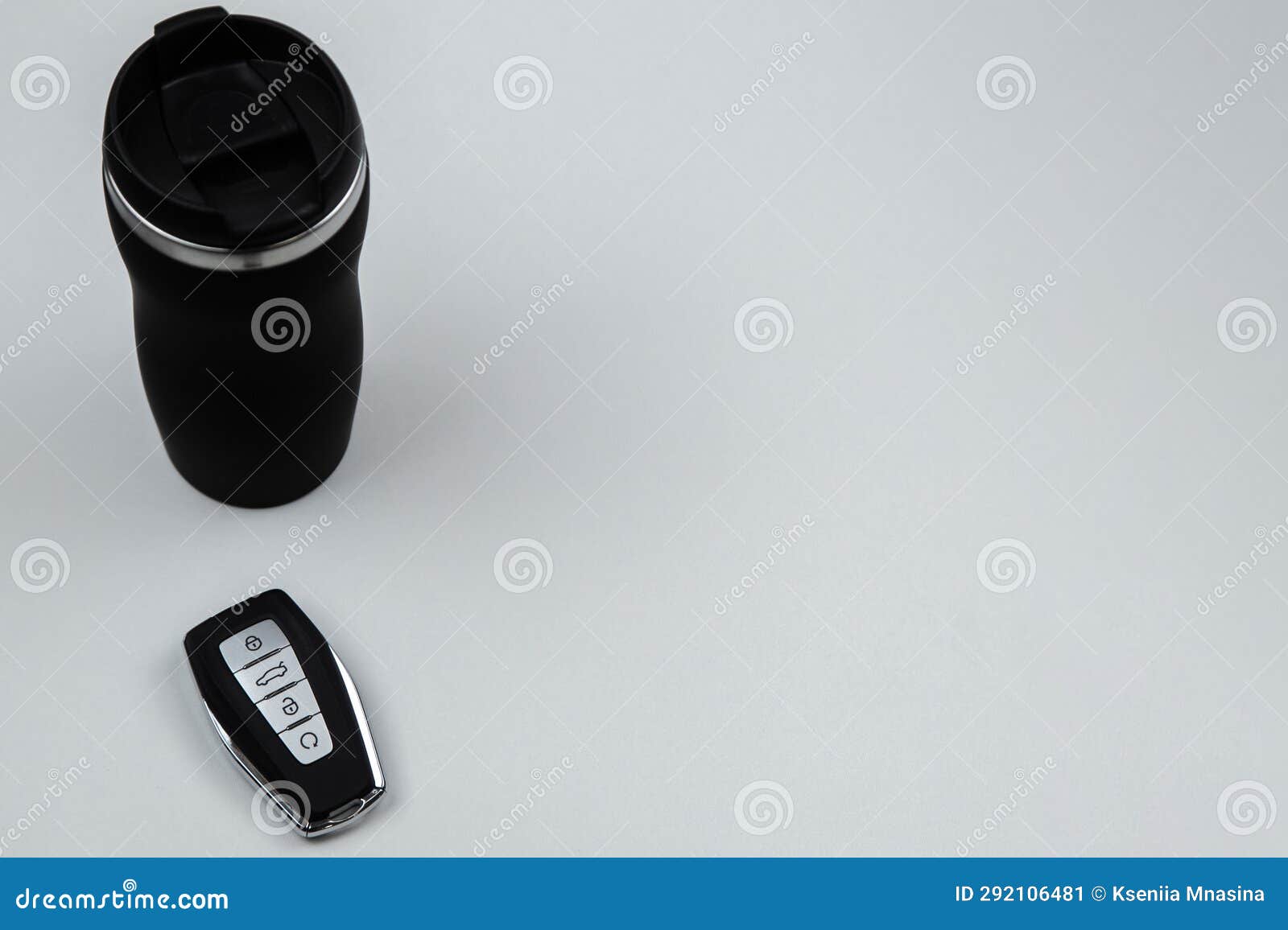 A Thermocup and a Key with Automatic Buttons in Black and with Metal ...