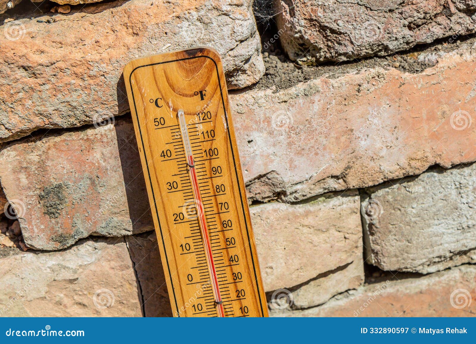 Thermometer Displaying High Summer Temperature on a Brick Wall Backgrou ...