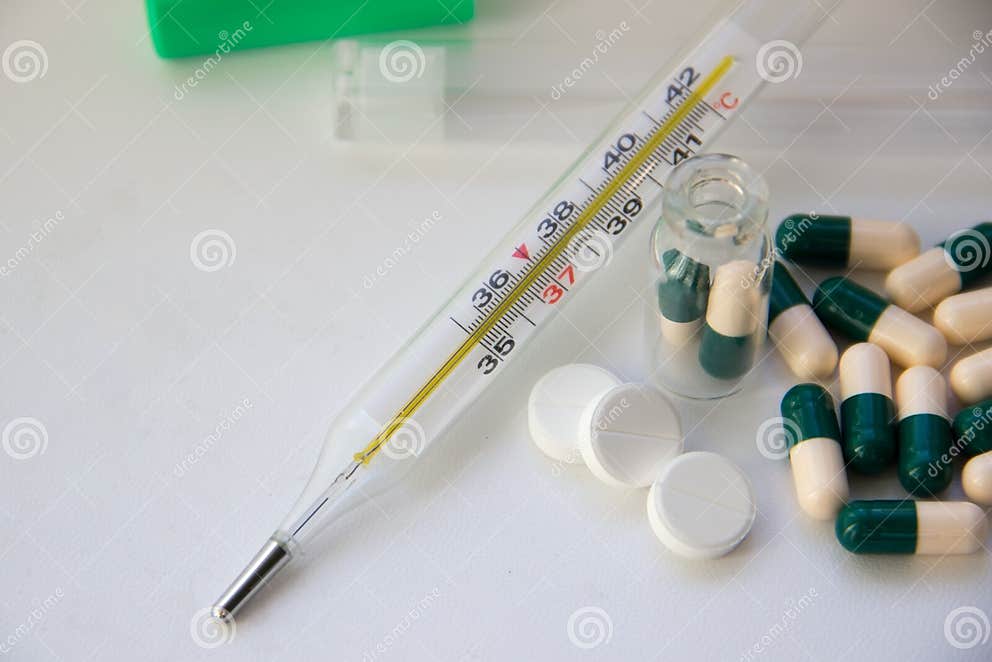 Thermometer with a Temperature of 38 and Tablets and Capsules Stock ...