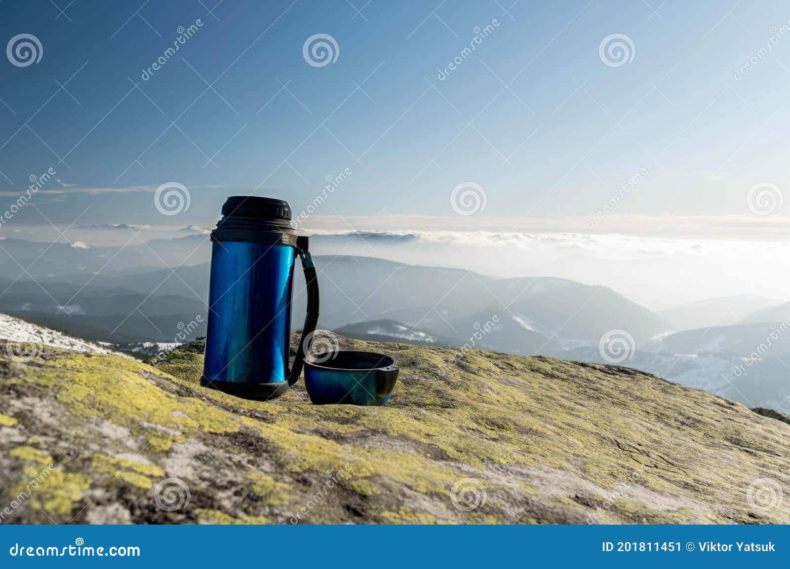 Thermos for Drinks on a Background of Mountains. Thermos on a Stone ...