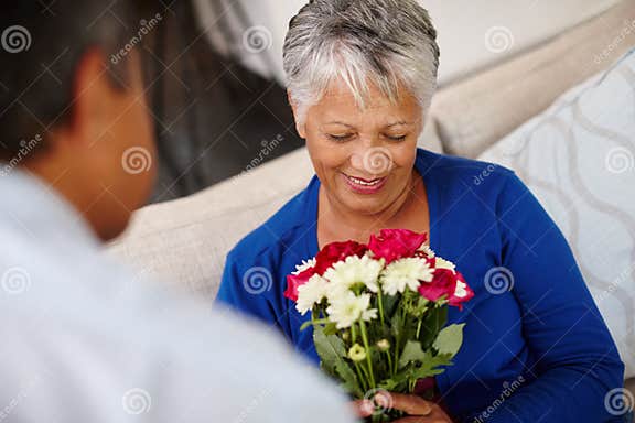 Theyre Beautiful My Darling A Happy Senior Woman Receiving A Bunch Of