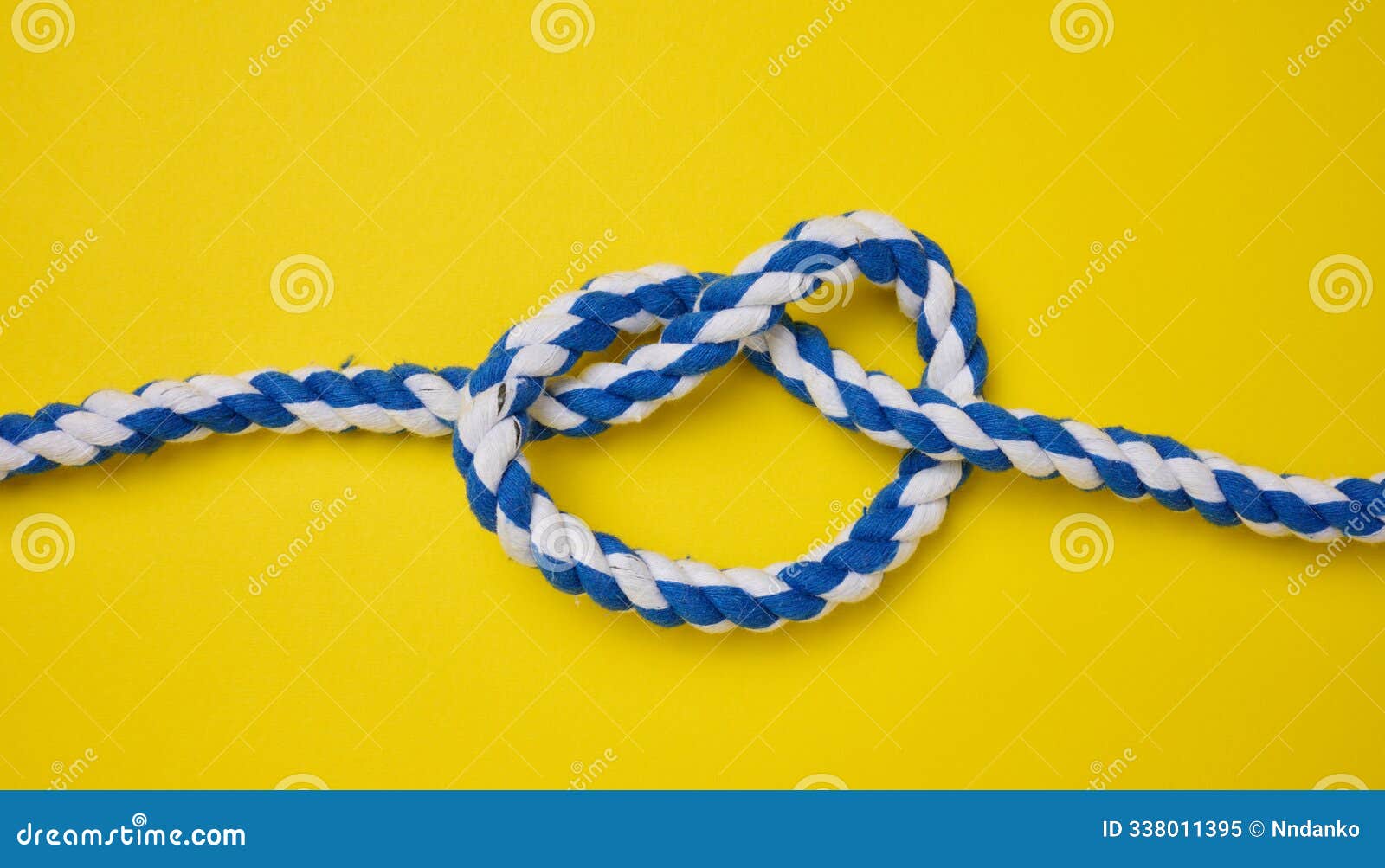 Thick Blue Rope Tied in a Knot on a Yellow Background Stock Image ...