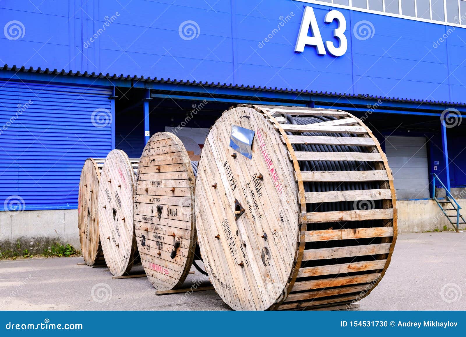A Thick Electrical Cable on Wooden Spools. Coils are Marked. Warehouse ...