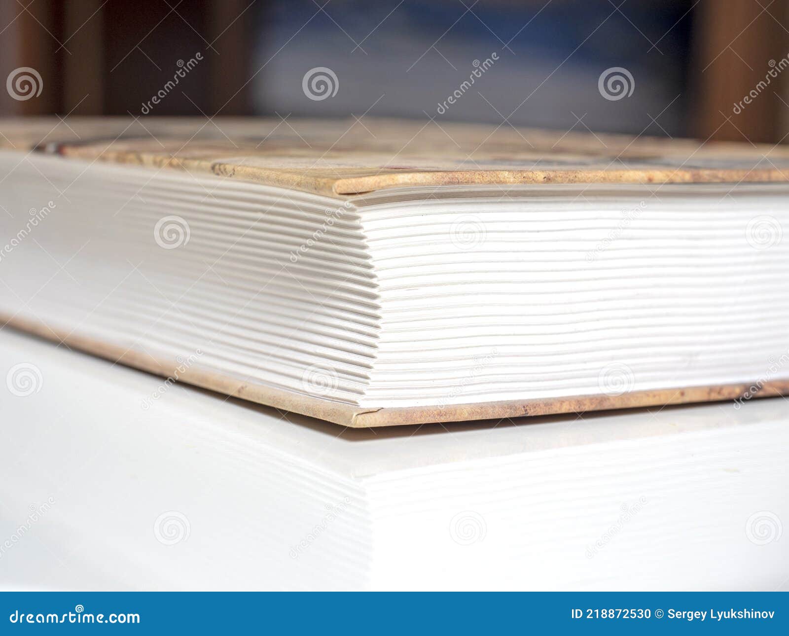 A Thick and Heavy Closed Book Lies on a White Surface in the House. the ...