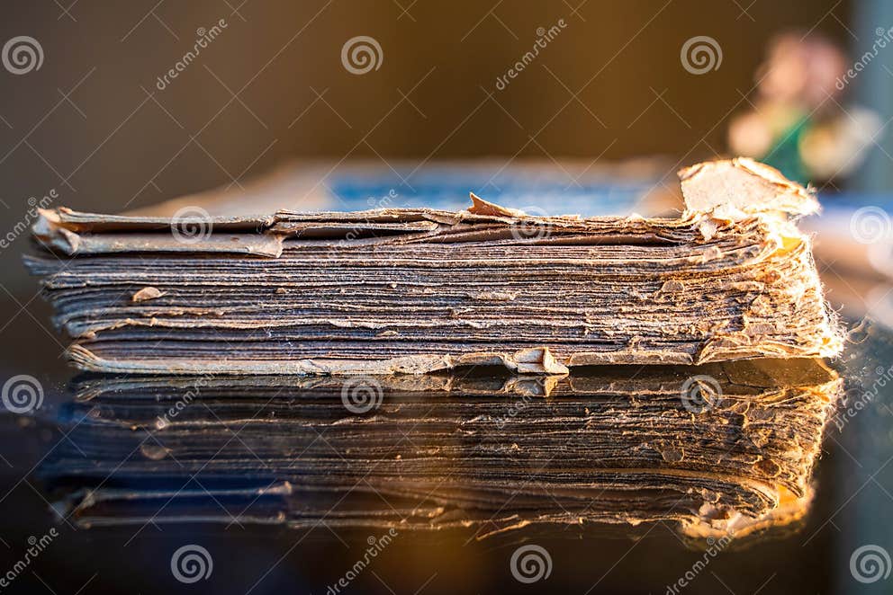 A Thick Large, Ragged, Old Torn Book on a Transparent Glass Table ...