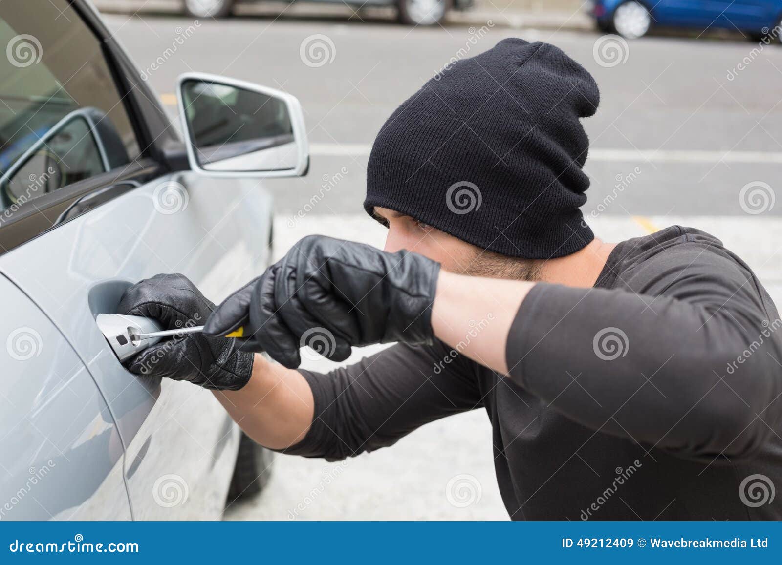 Thief Breaking Lock To Open The Gate. Male Thief Trying To Open Gate ...