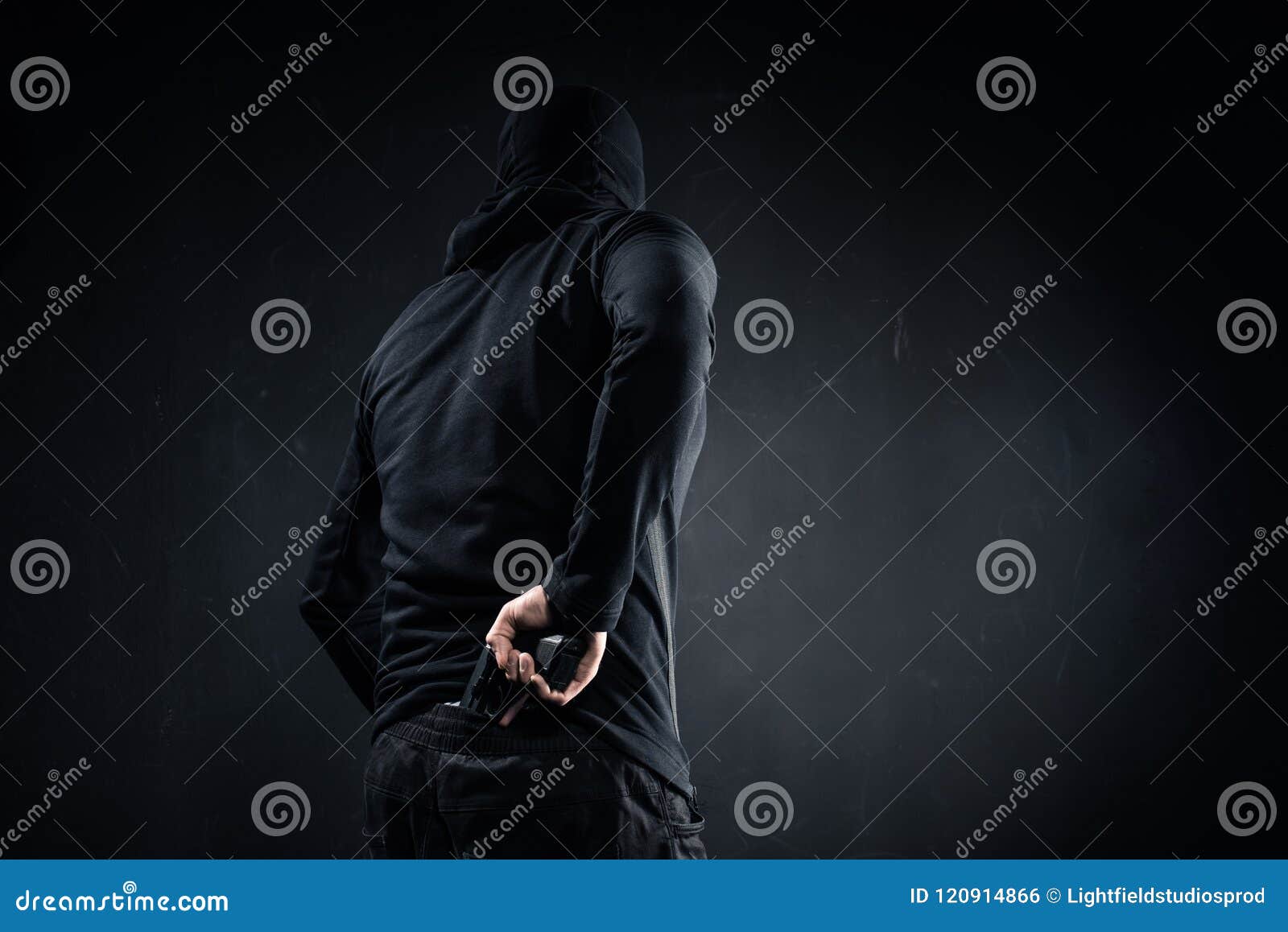Thief hiding gun behind stock photo. Image of robbery - 120914866
