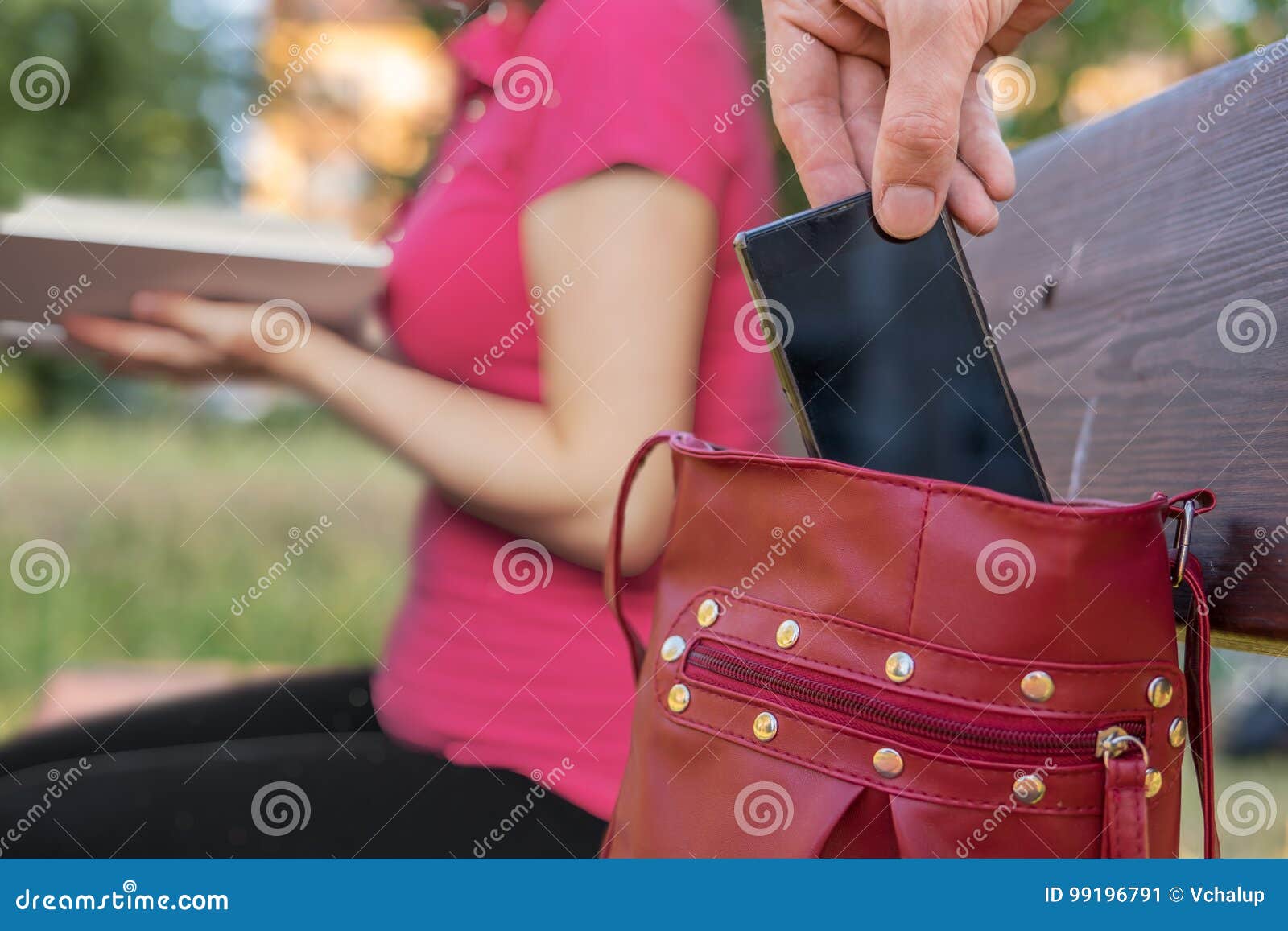 Thief is Stealing Smartphone from Bag of a Woman Sitting on Bench Stock ...