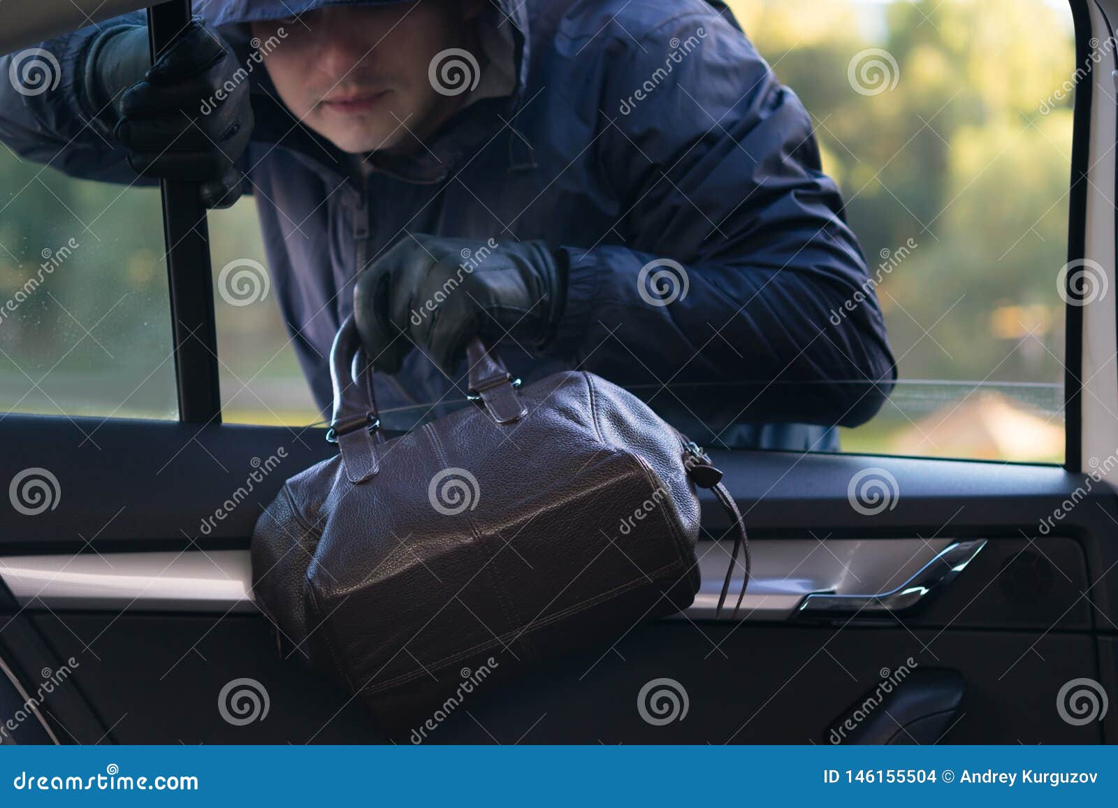 The Thief Steals a Bag from the Car through the Open Glass Stock Photo ...