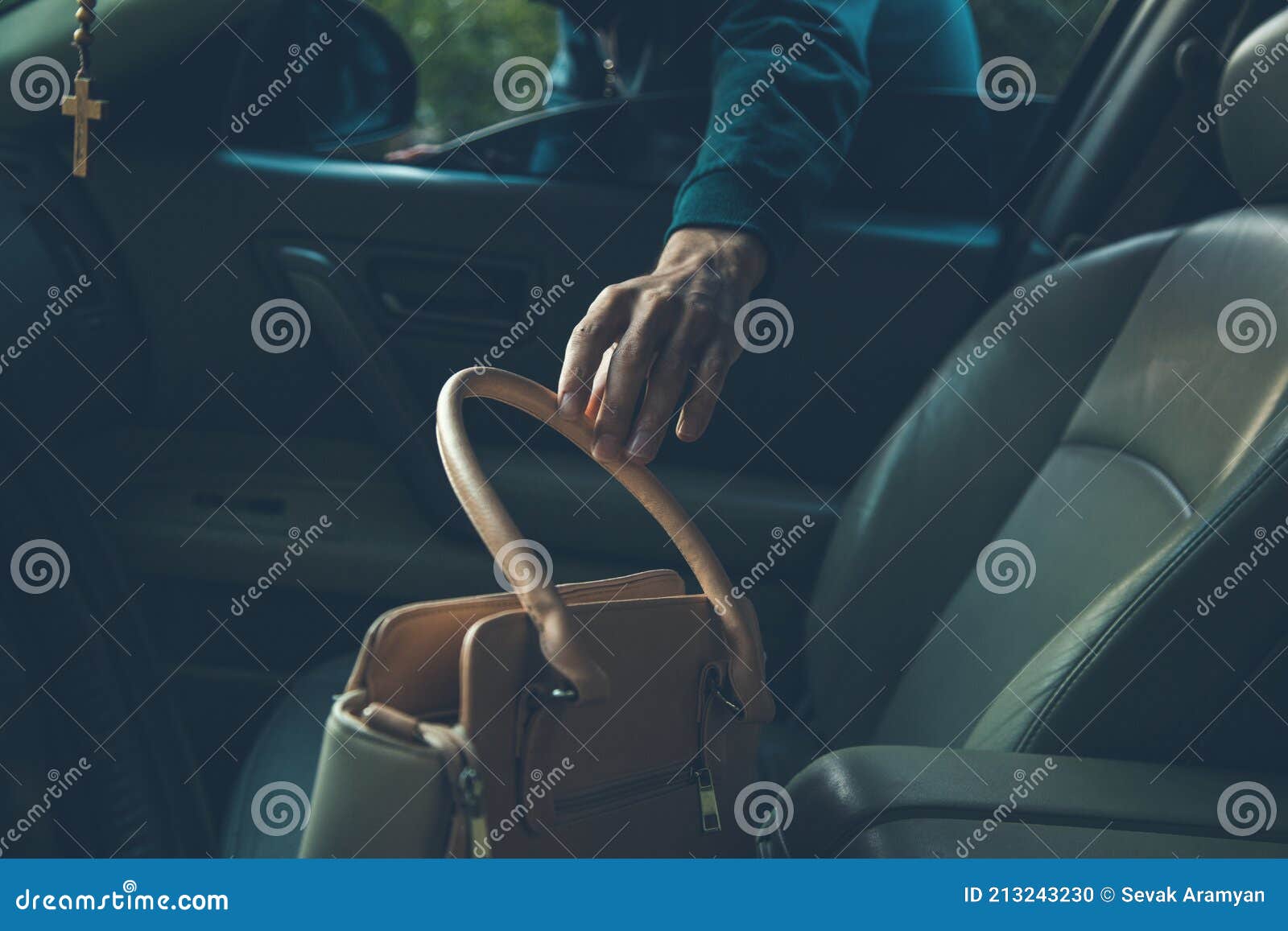 A thief steals bag in car stock photo. Image of mask - 213243230