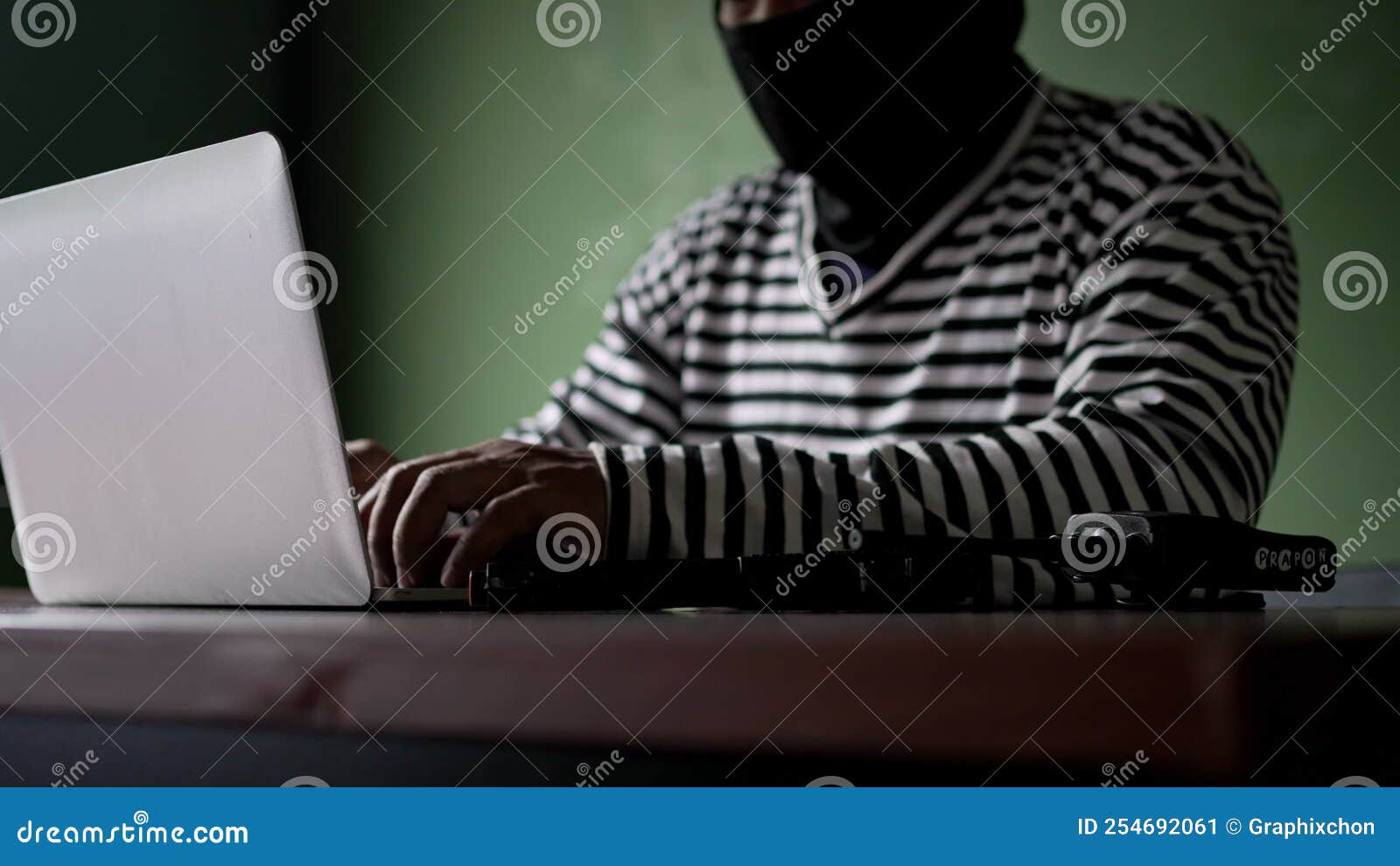Thief Use Computer for Theft. Hacker Stealing Data from a Laptop ...