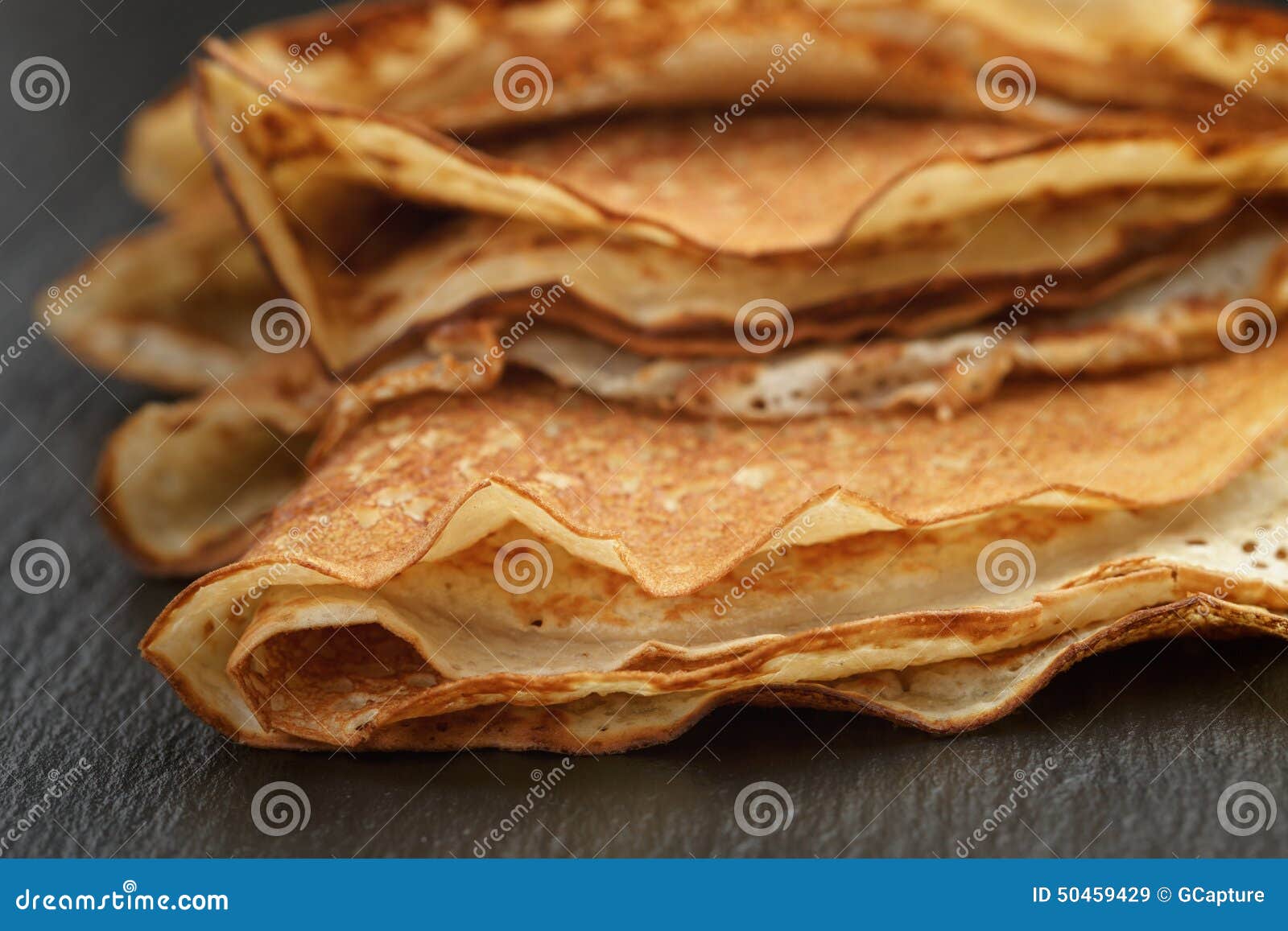 Thin Crepes or Blinis Folded in Triangles on Slate Stock Image - Image ...