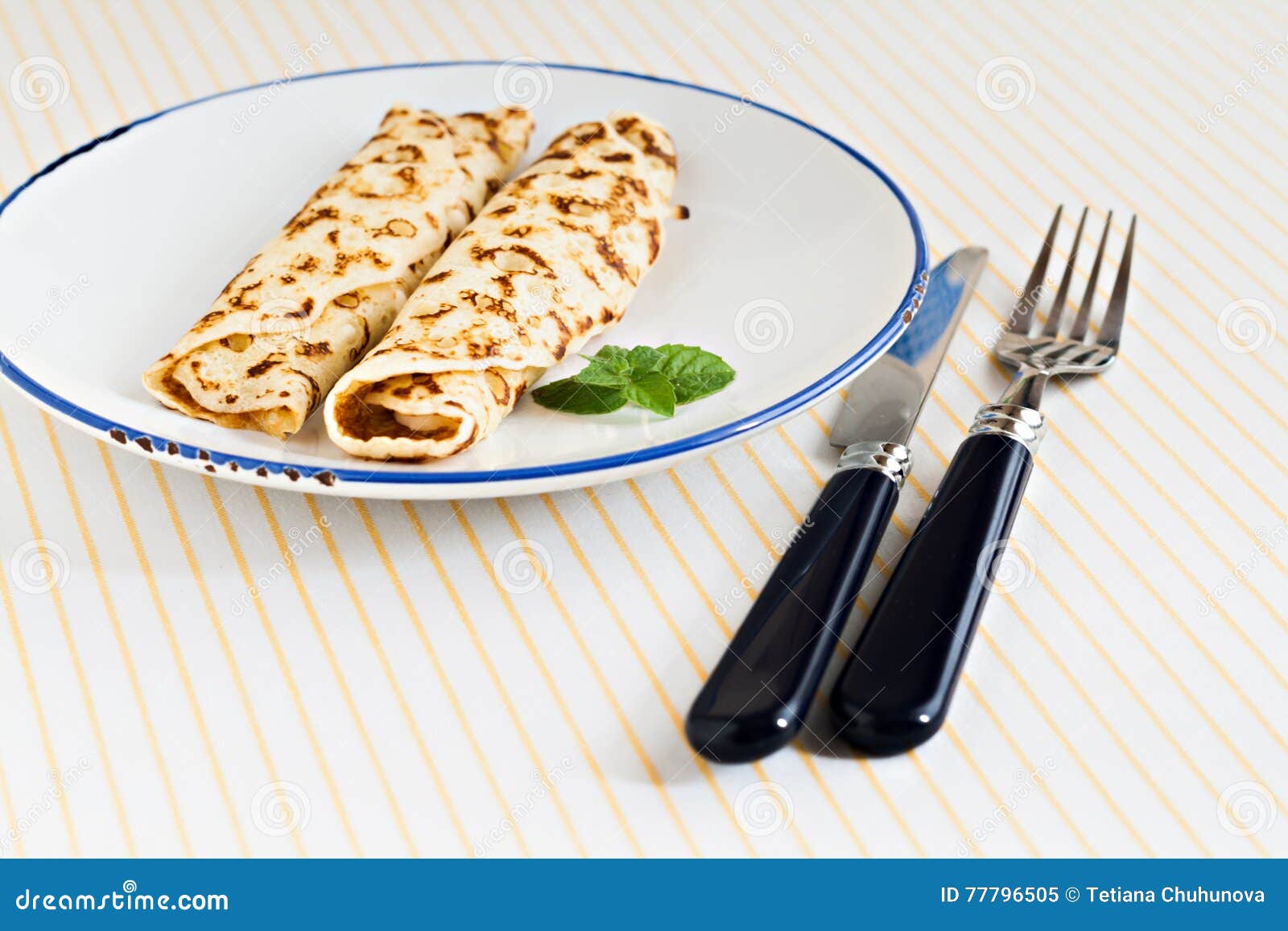 Thin Pancakes Rolled Crepes Mint on a Plate with Knife and Fork Stock ...