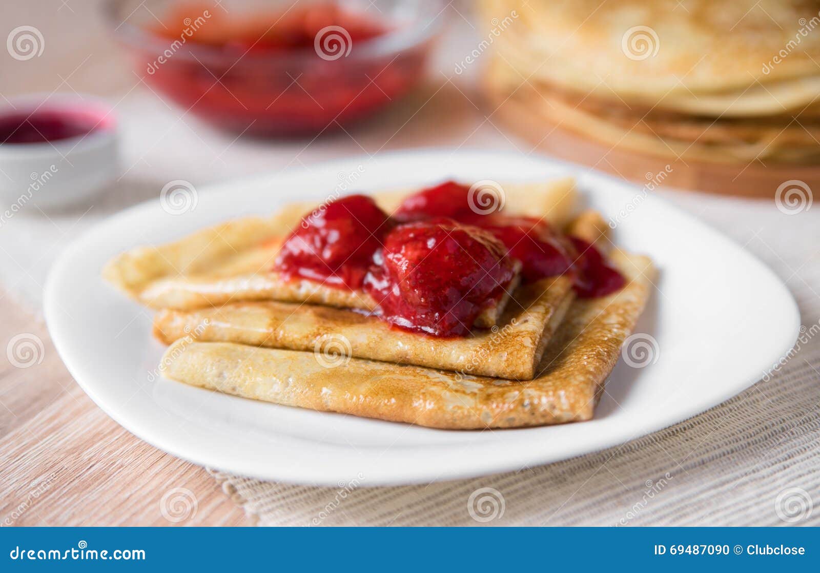 Thin Russian Pancakes Folded Triangle with Strawberry Sauce on a White ...