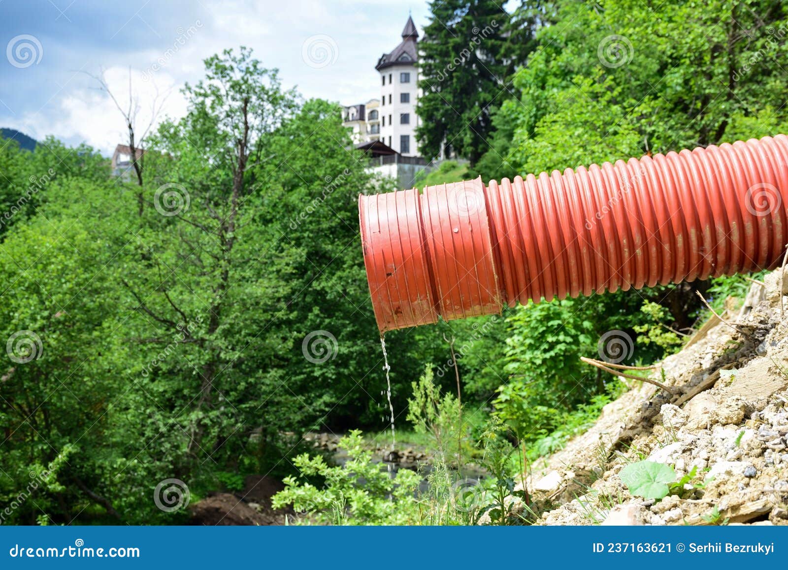 A Thin Stream of Water Flows from a Sewer Plastic Pipe Against a ...