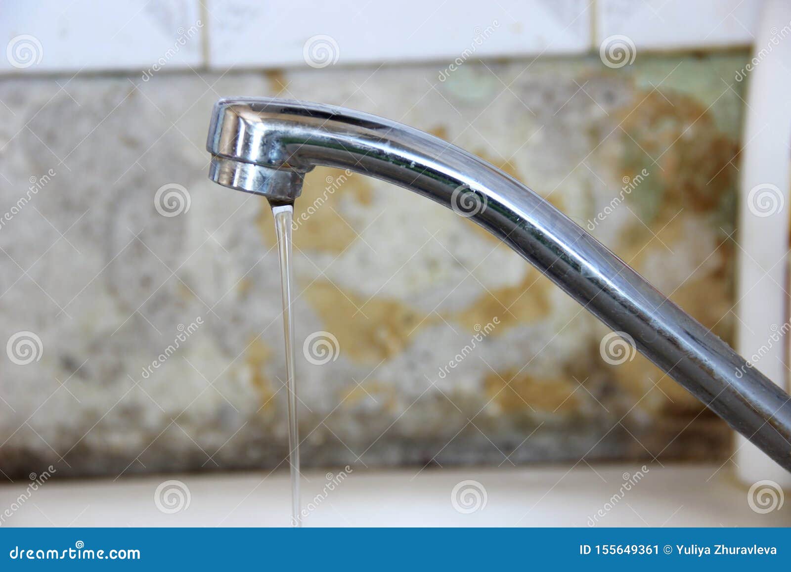 A Thin Stream of Water Flows from the Tap, Silver Colored Kitchen ...