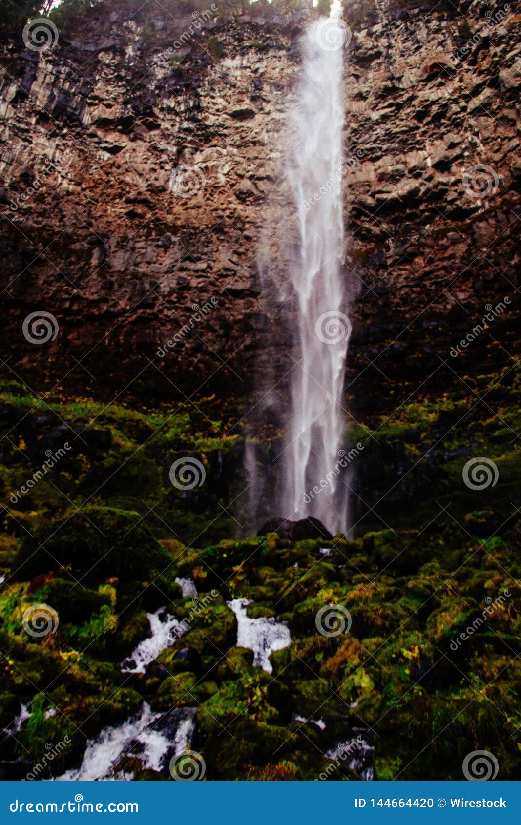 A Thin Waterfall Dripping Down a Rocky Terrain Stock Photo - Image of ...