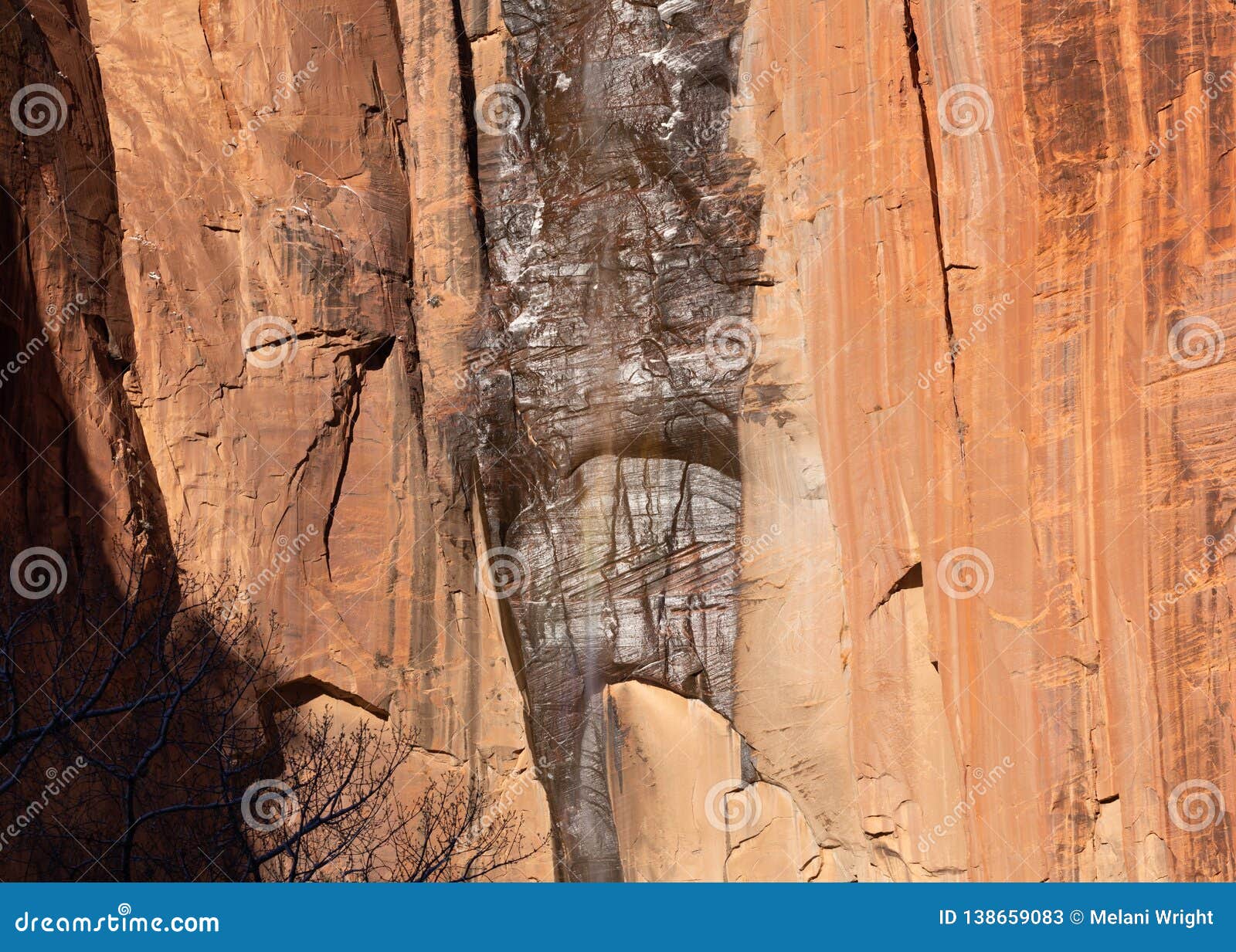A Thin Waterfall Reflects a Bit of Rainbow As it Comes Down the Face of ...