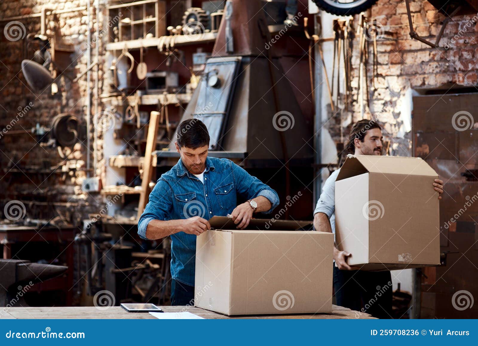Things Get Easier when we Work Together. Two Young Businessmen Carrying ...