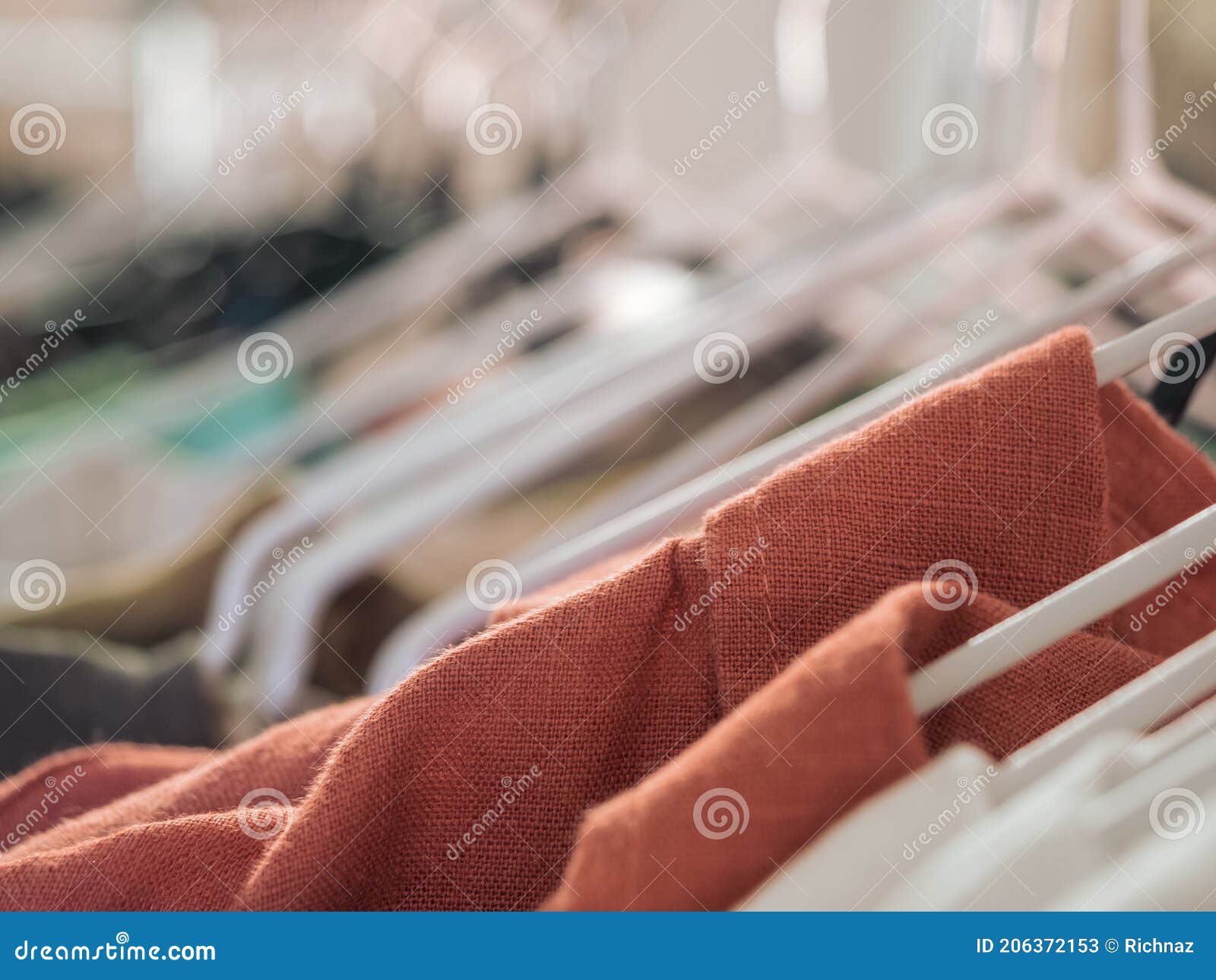 Things Made of Natural Linen in Different Colors Hang on Hangers in the ...