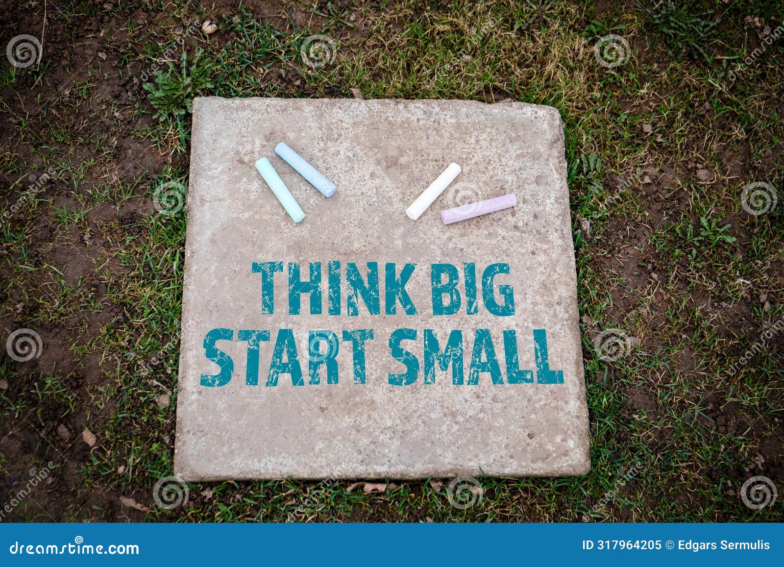 THINK BIG START SMALL. Colored Pieces of Chalk on a Concrete Pavement ...