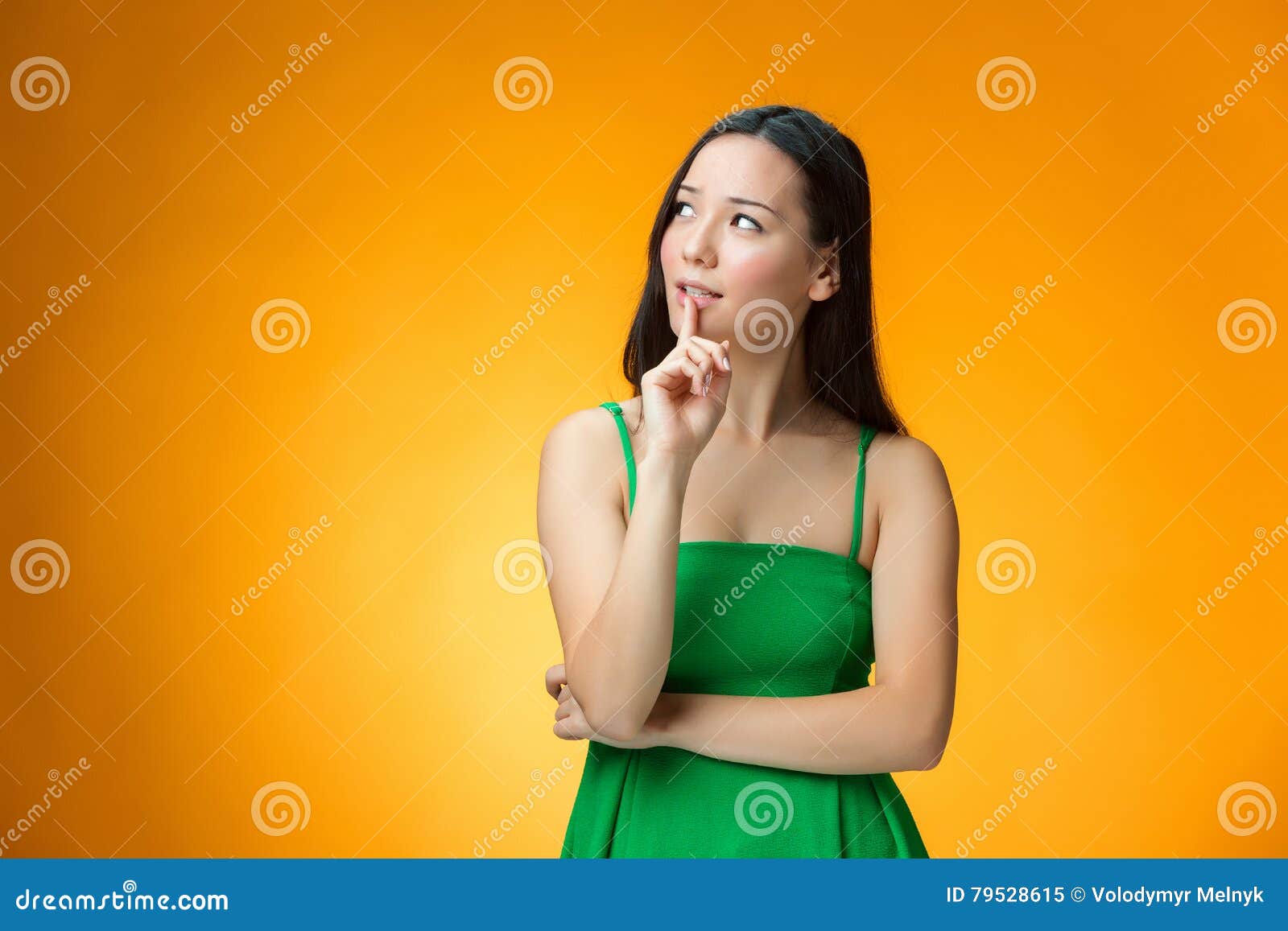 The Thinking Chinese Girl On Yellow Background Stock Photo ...