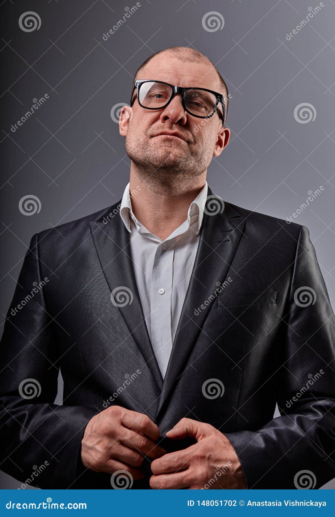 Thinking Fun Bald Business Man Looking Serious In Eyeglasses In Suit On ... Thinking Fun Bald Business Man Looking Serious In Eyeglasses In Suit On ...