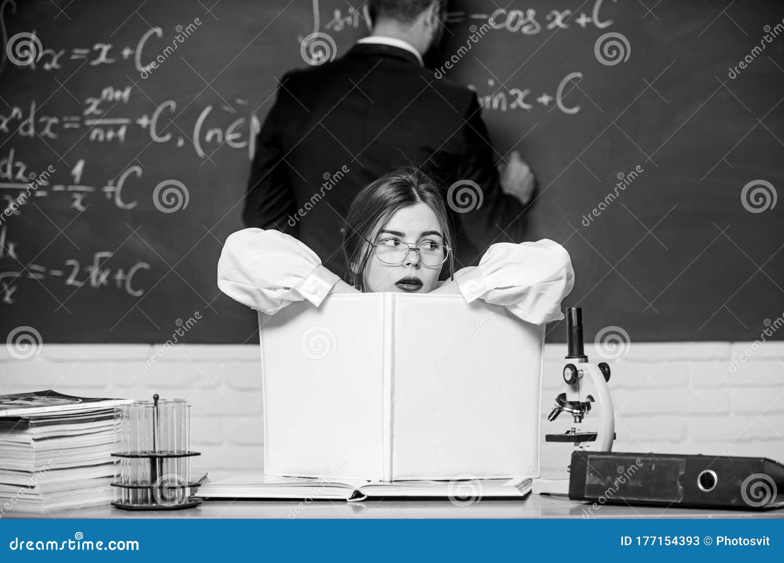 Thinking Hard. Pretty Teacher Giving Homework. Student Writing Homework ...