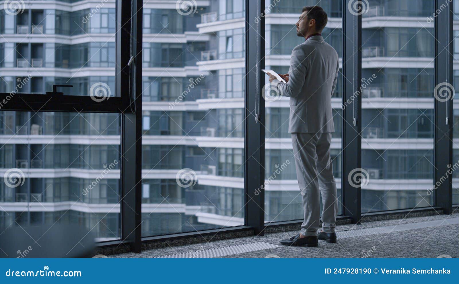 Thinking Man Executive Standing Using Tablet Working Online in Window ...