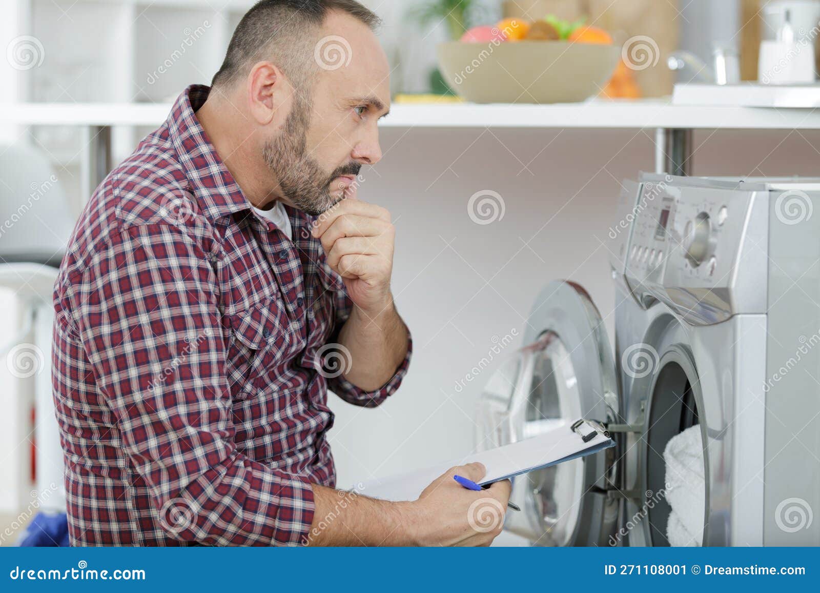 Thinking Plumber with Clipboard Near Washing Machine Stock Image ...