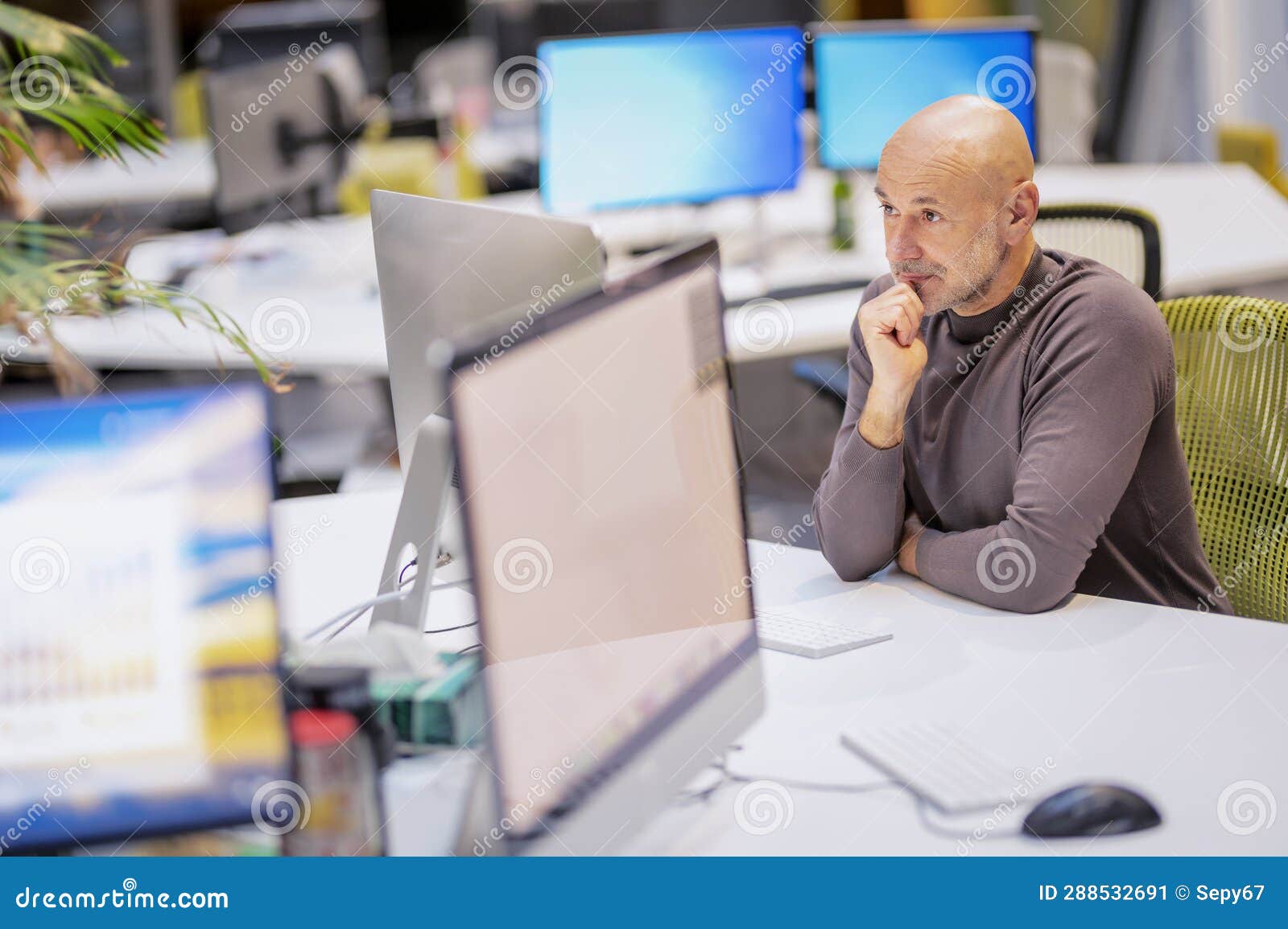 Thinking Professional Man Sitting at Desk and Surrounded by Computers ...