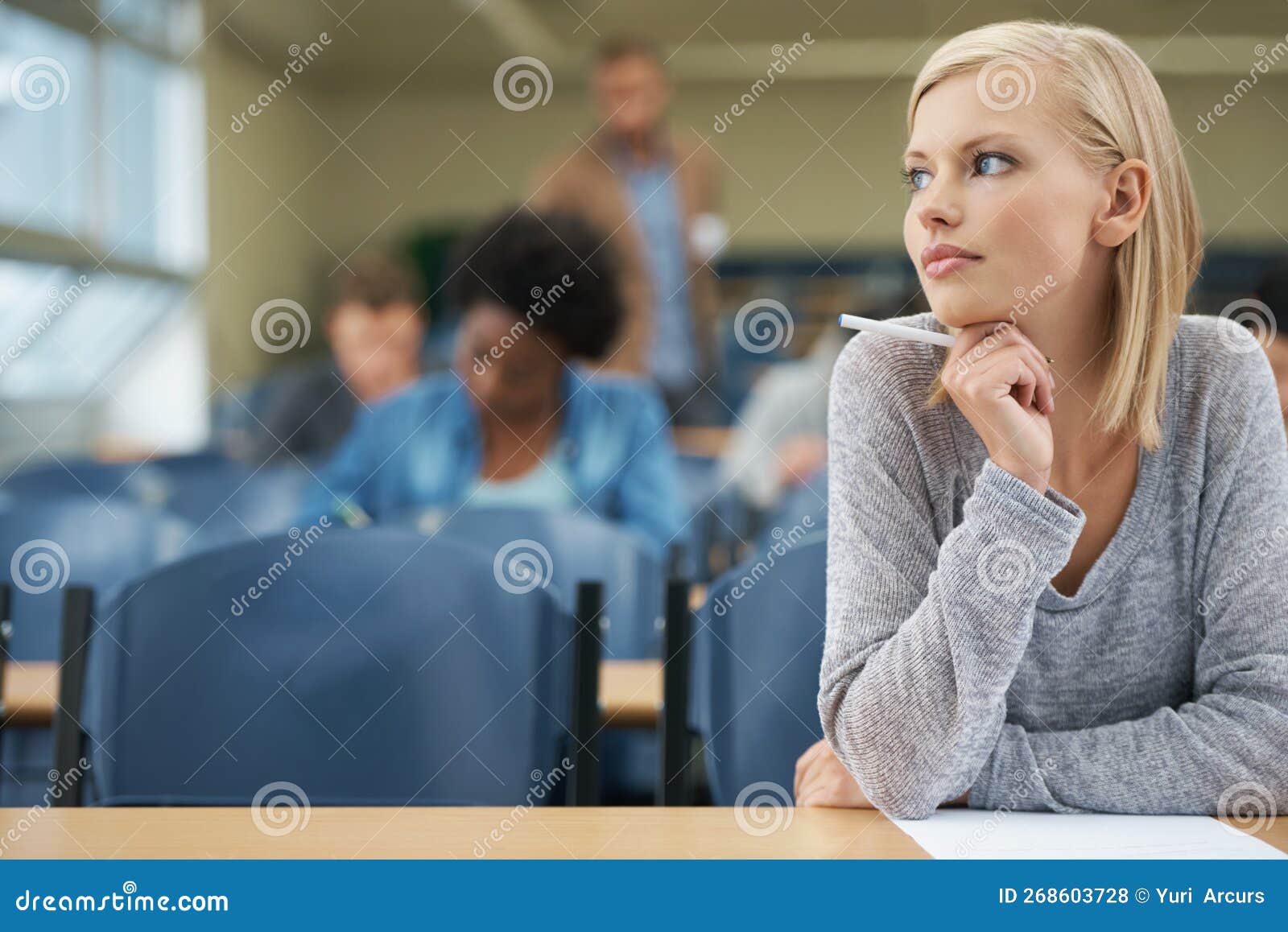 Thinking of the Right Answer...a Pretty Blonde Student Writing Exam in ...