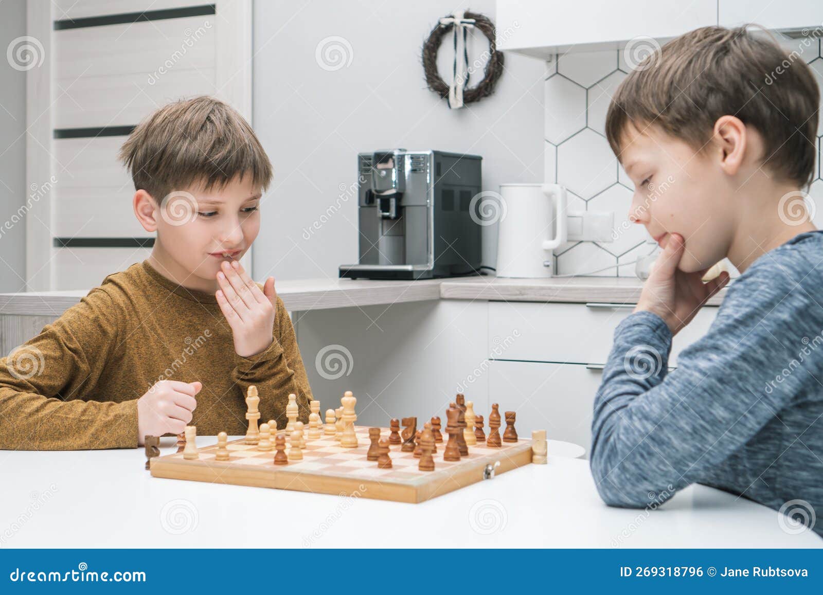 Schoolboys Play Chess On Kitchen Table, Side View. Chessboard With ...