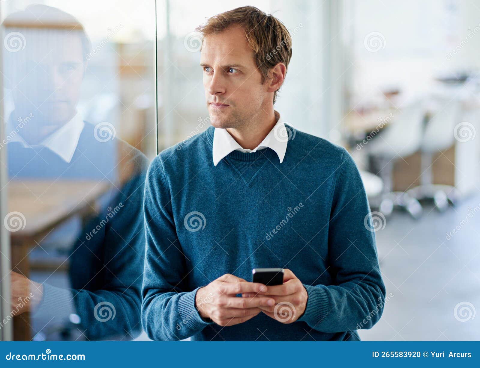 Thinking Things Over. a Handsome Young Businessman Using His Cellphone ...