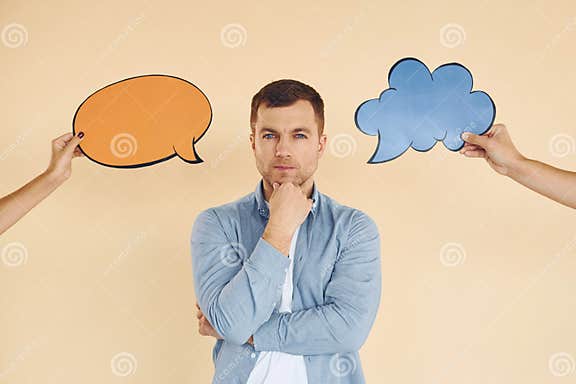 Thinking about Two Ideas. Man Standing in the Studio with Empty Signs ...