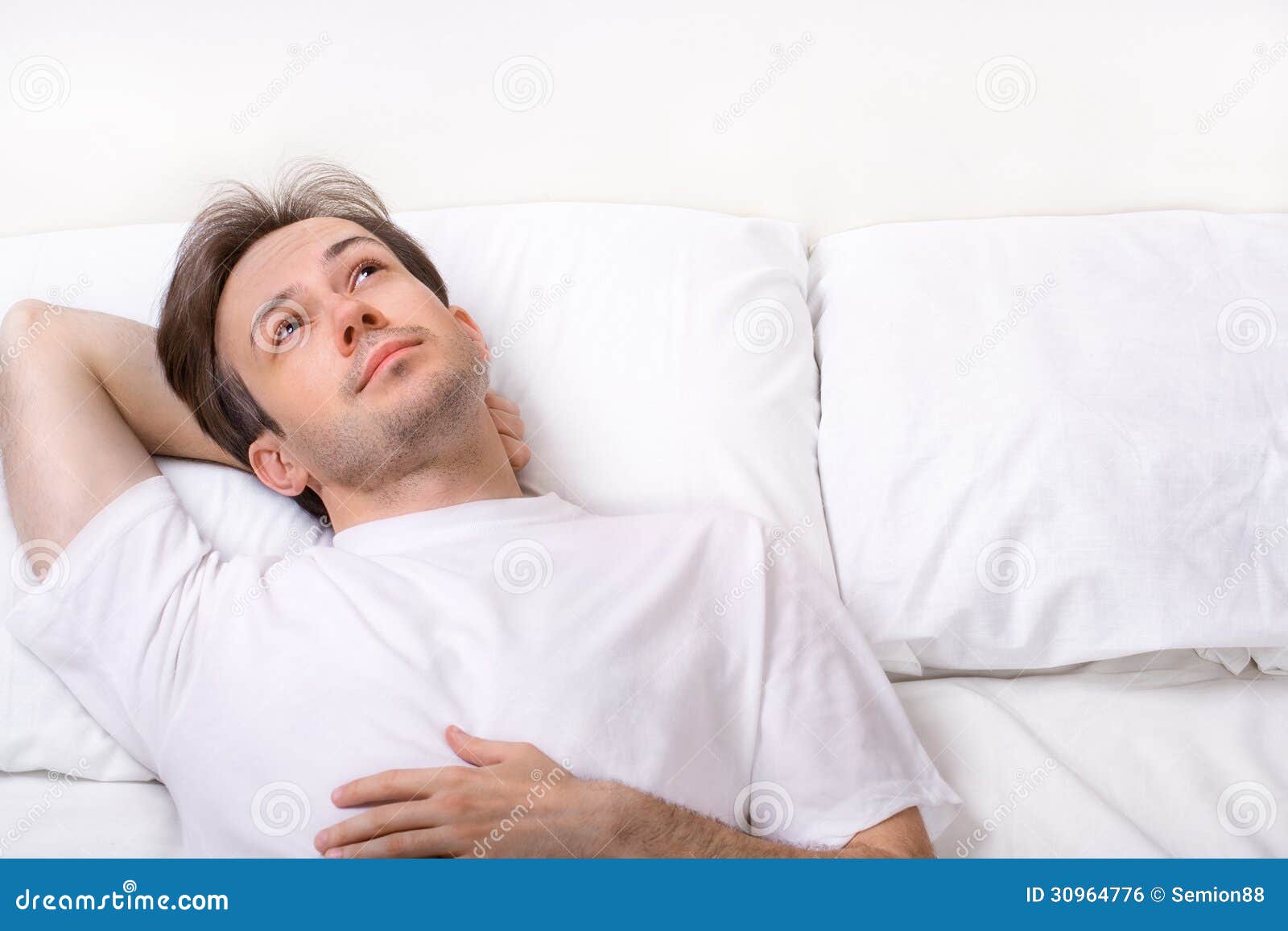 Thinking Young Man Lying on Bed Stock Photo - Image of pensive, human ...
