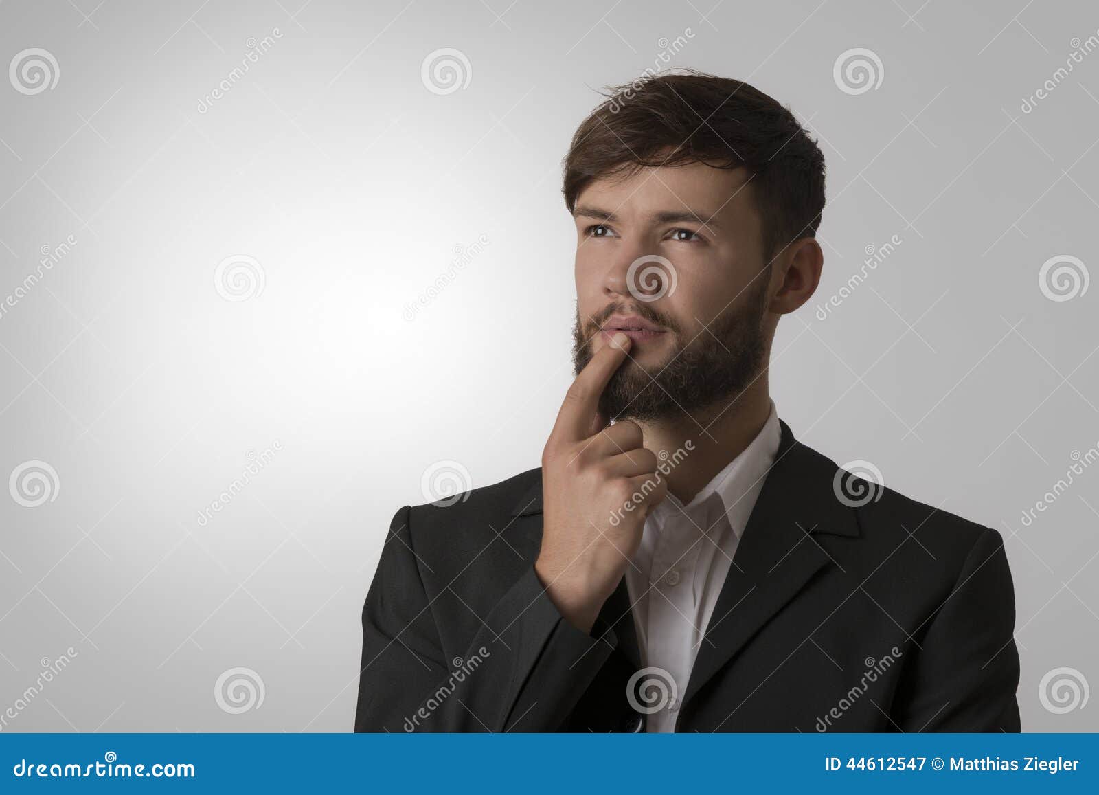 Thinking young man in suit stock image. Image of stylish - 44612547