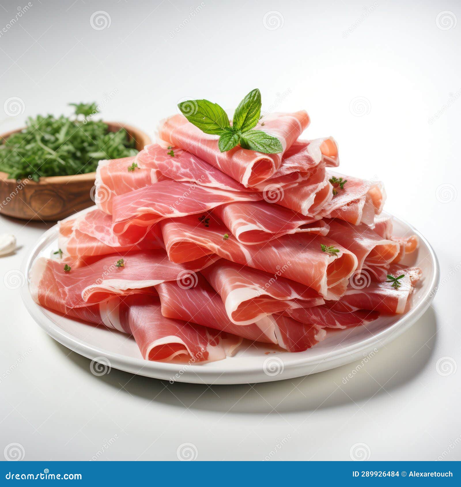 Thinly Sliced Jamon with Green Leaves on a Plate on the Table Stock ...