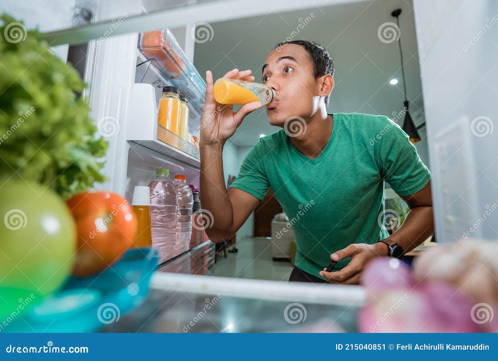 Thirsty Young Man Taking a Drink in the Fridge and Drink it Stock Image ...