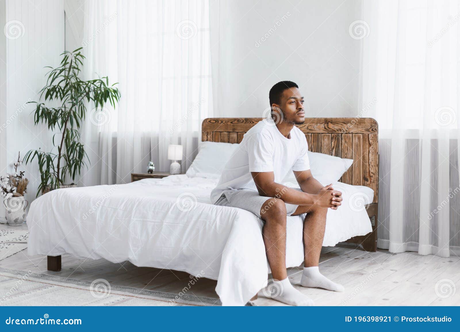 Thoughtful African American Man Thinking Sitting on Bed at Home Stock ... Thoughtful African American Man Thinking Sitting on Bed at Home Stock ...